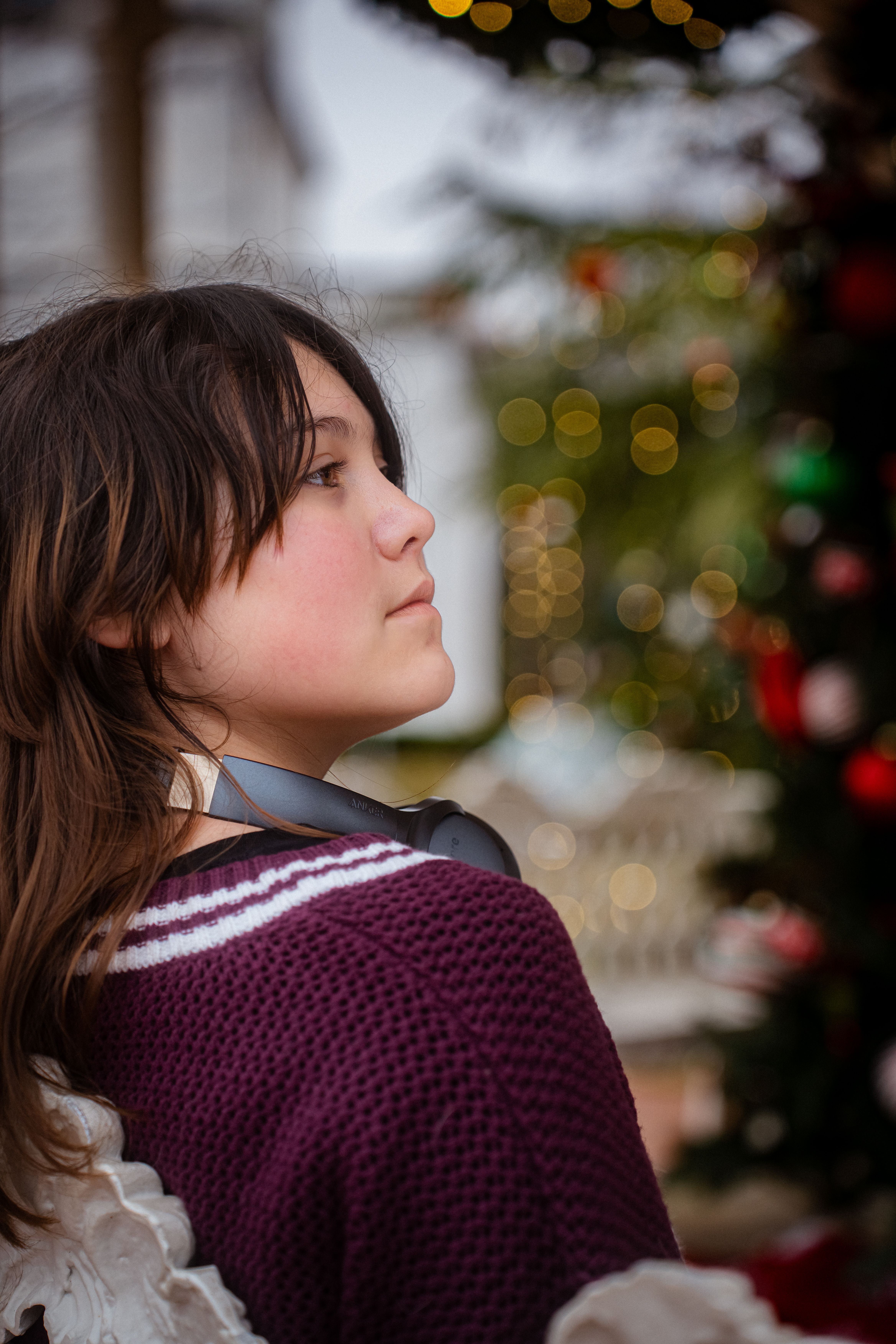 Contemplative Child by a Christmas Tree · Free Stock Photo