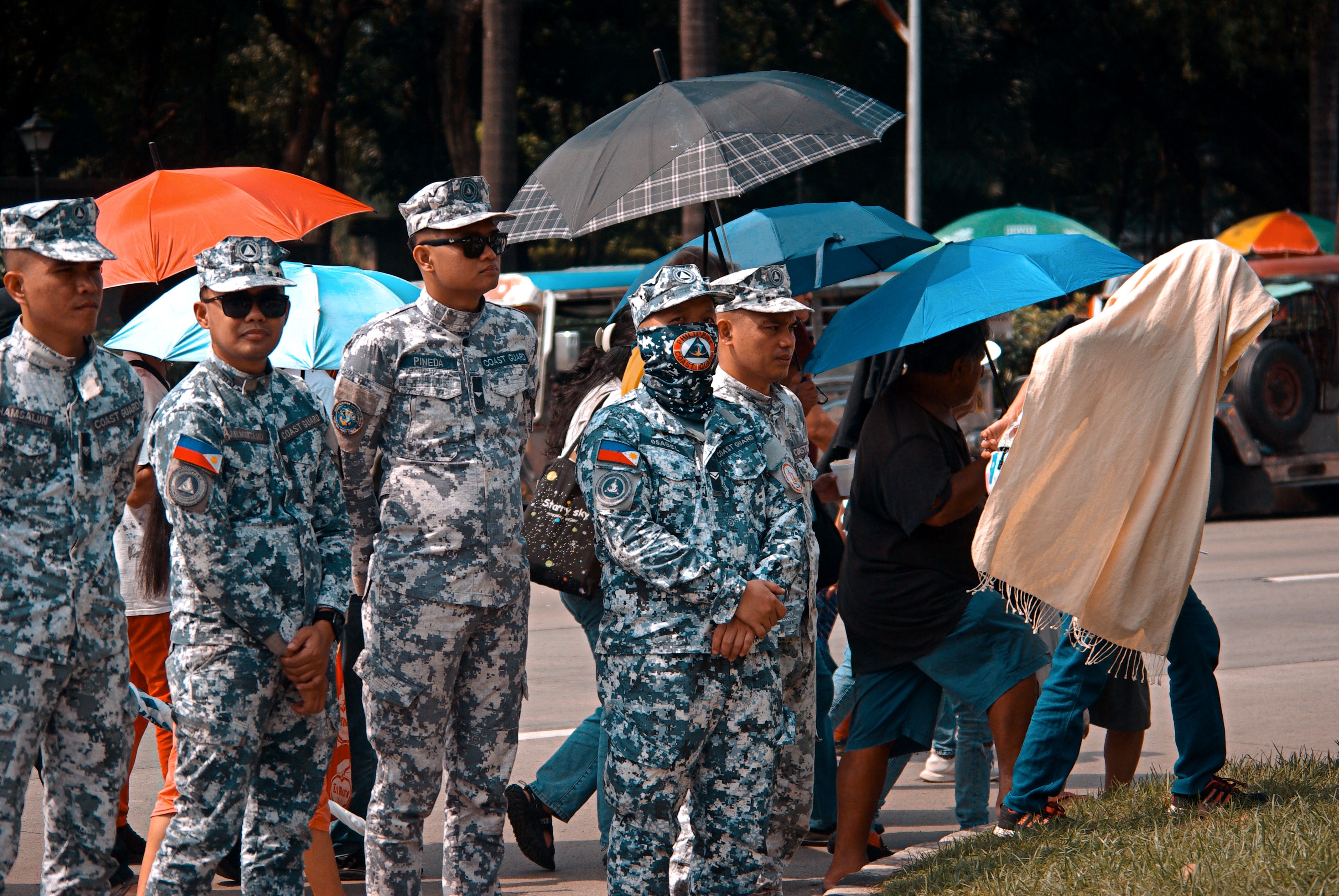 Soldiers Standing with Umbrellas on a Rainy Day · Free Stock Photo