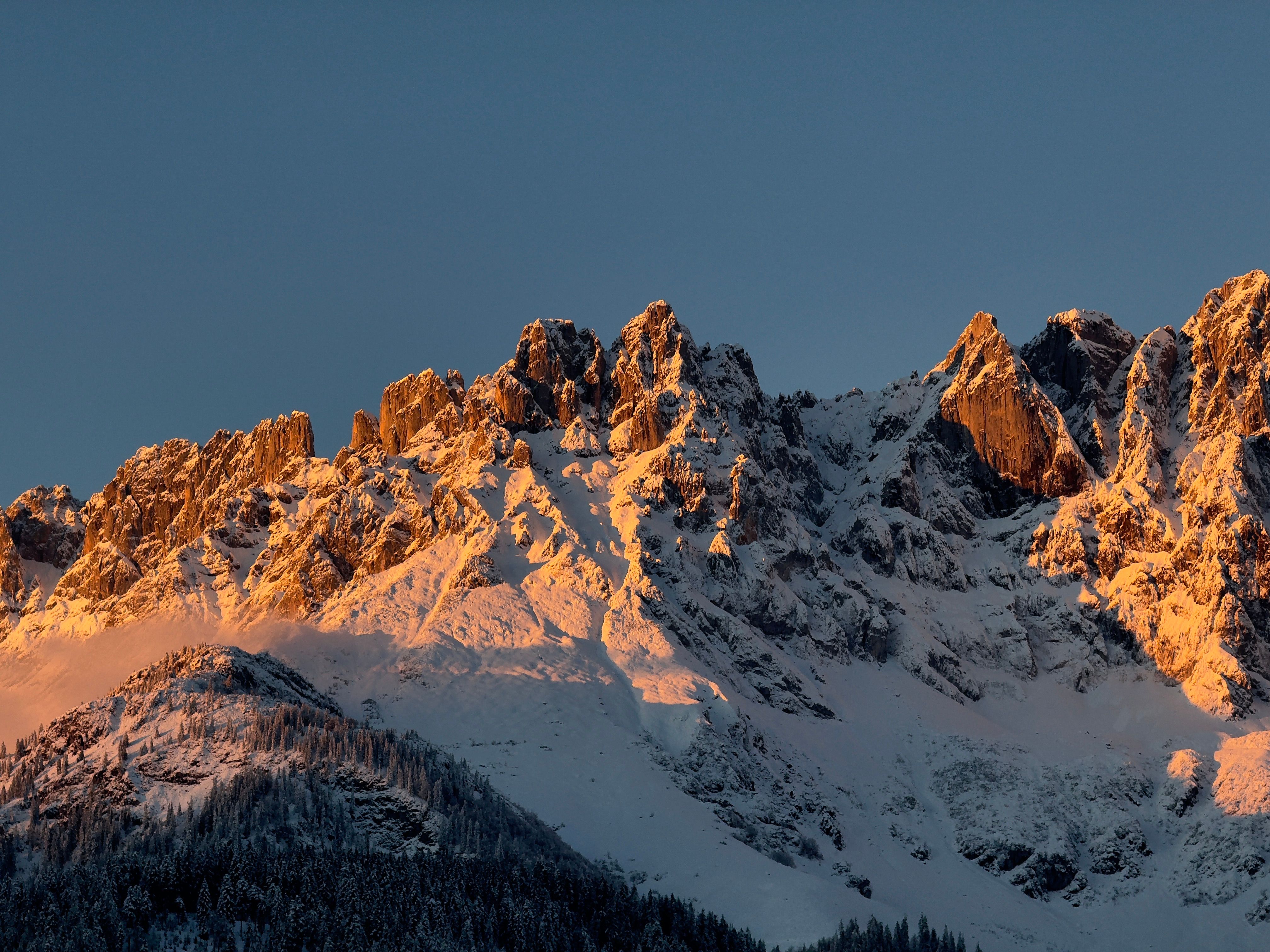 Sunlit Snowy Mountain Peaks at Sunrise · Free Stock Photo