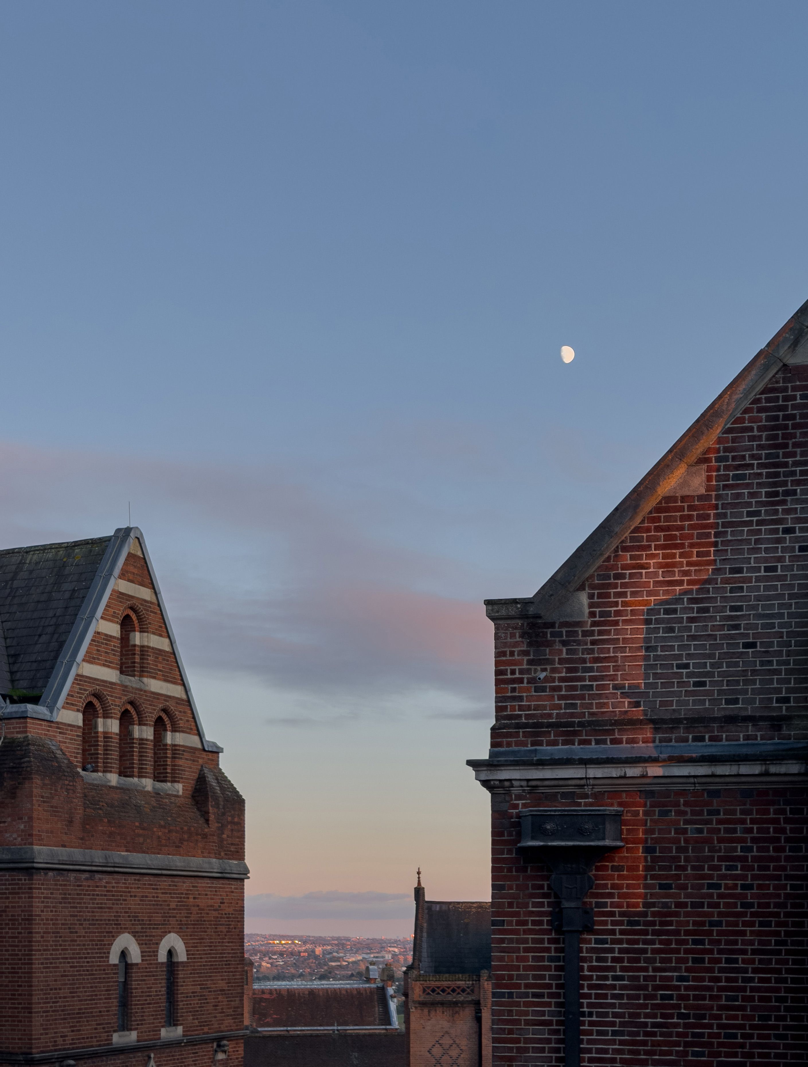 Historic Buildings With Moon in Evening Sky · Free Stock Photo