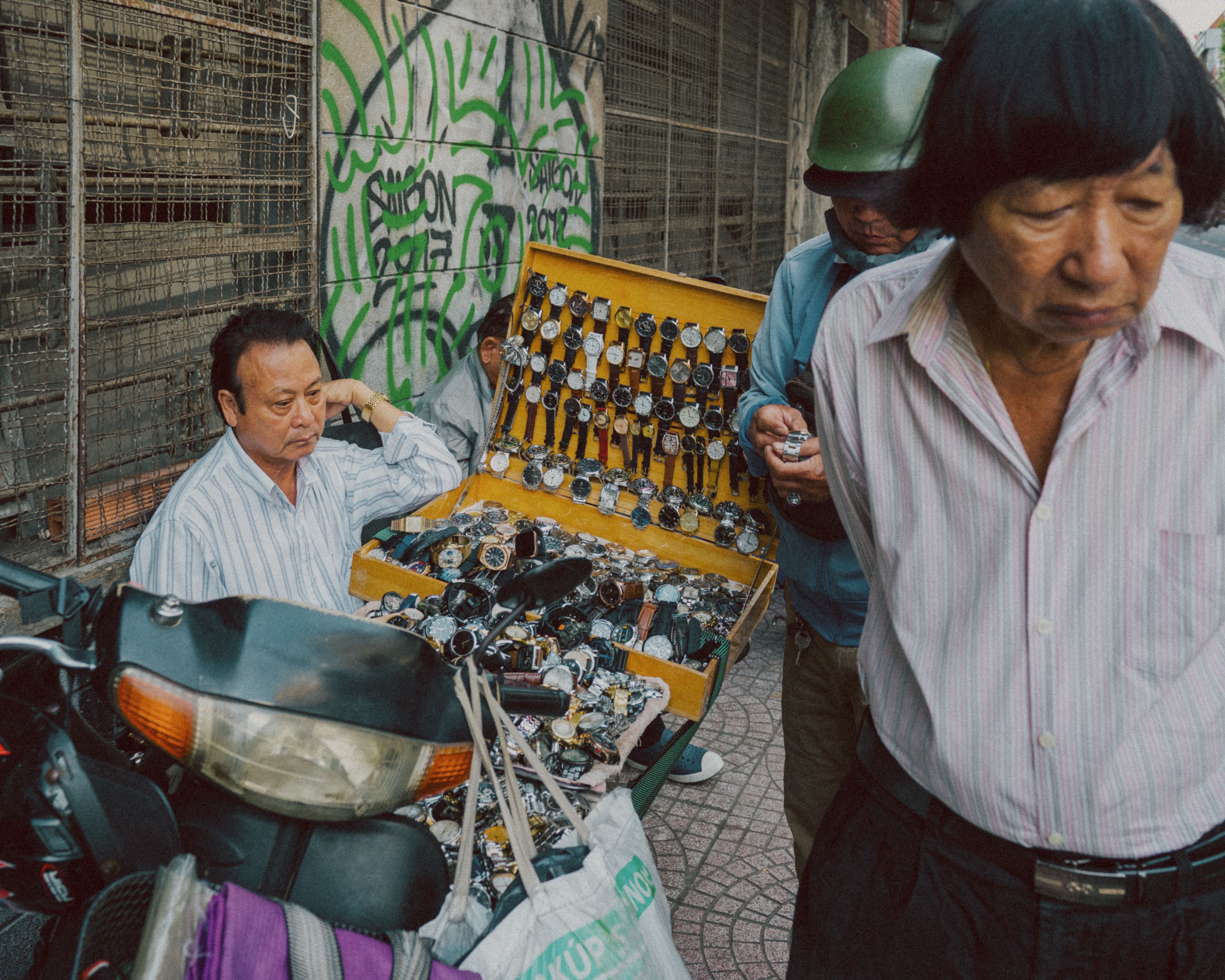 Street Vendor Selling Watches in Urban Setting · Free Stock Photo