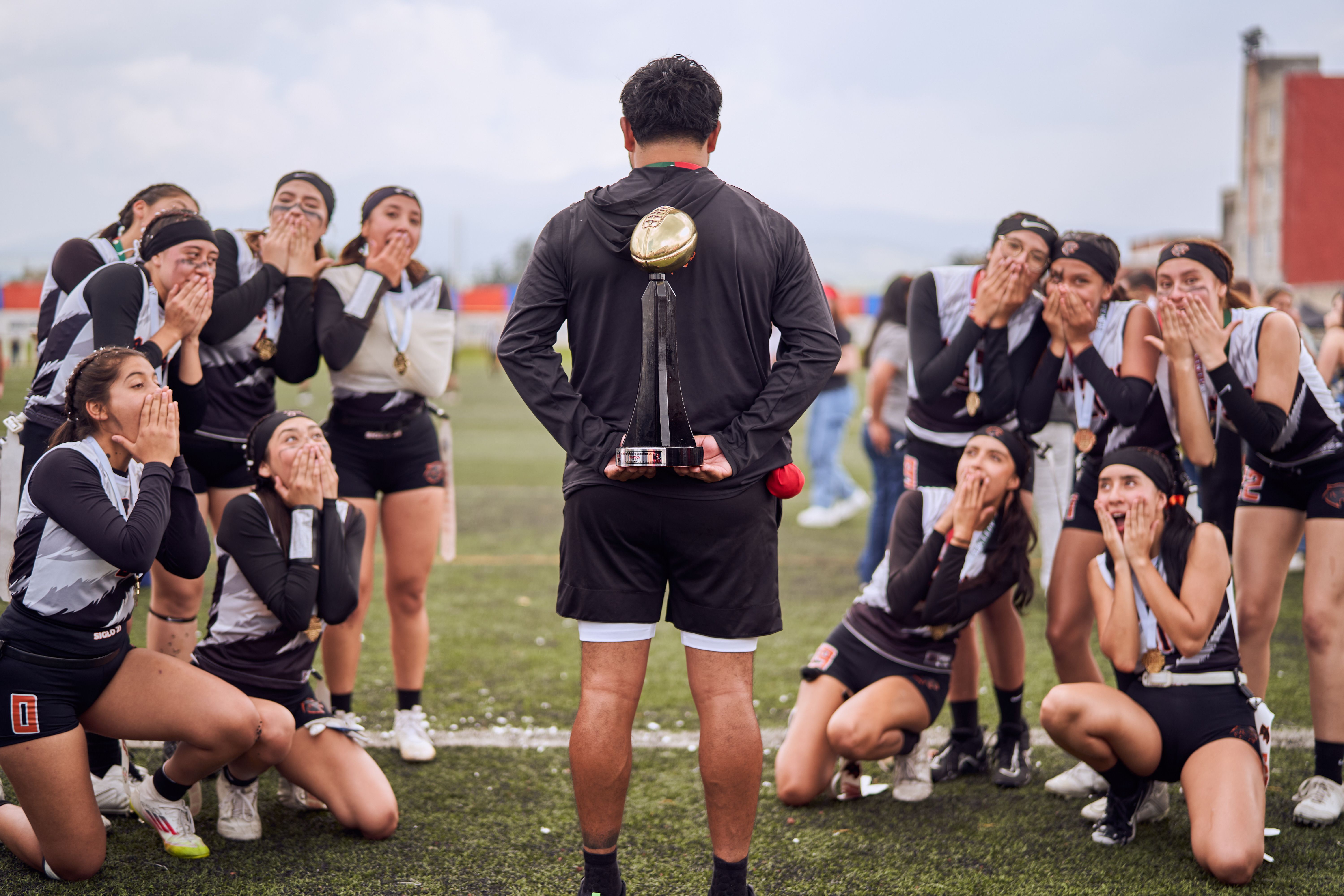 Victory Celebration with Trophy on Soccer Field · Free Stock Photo