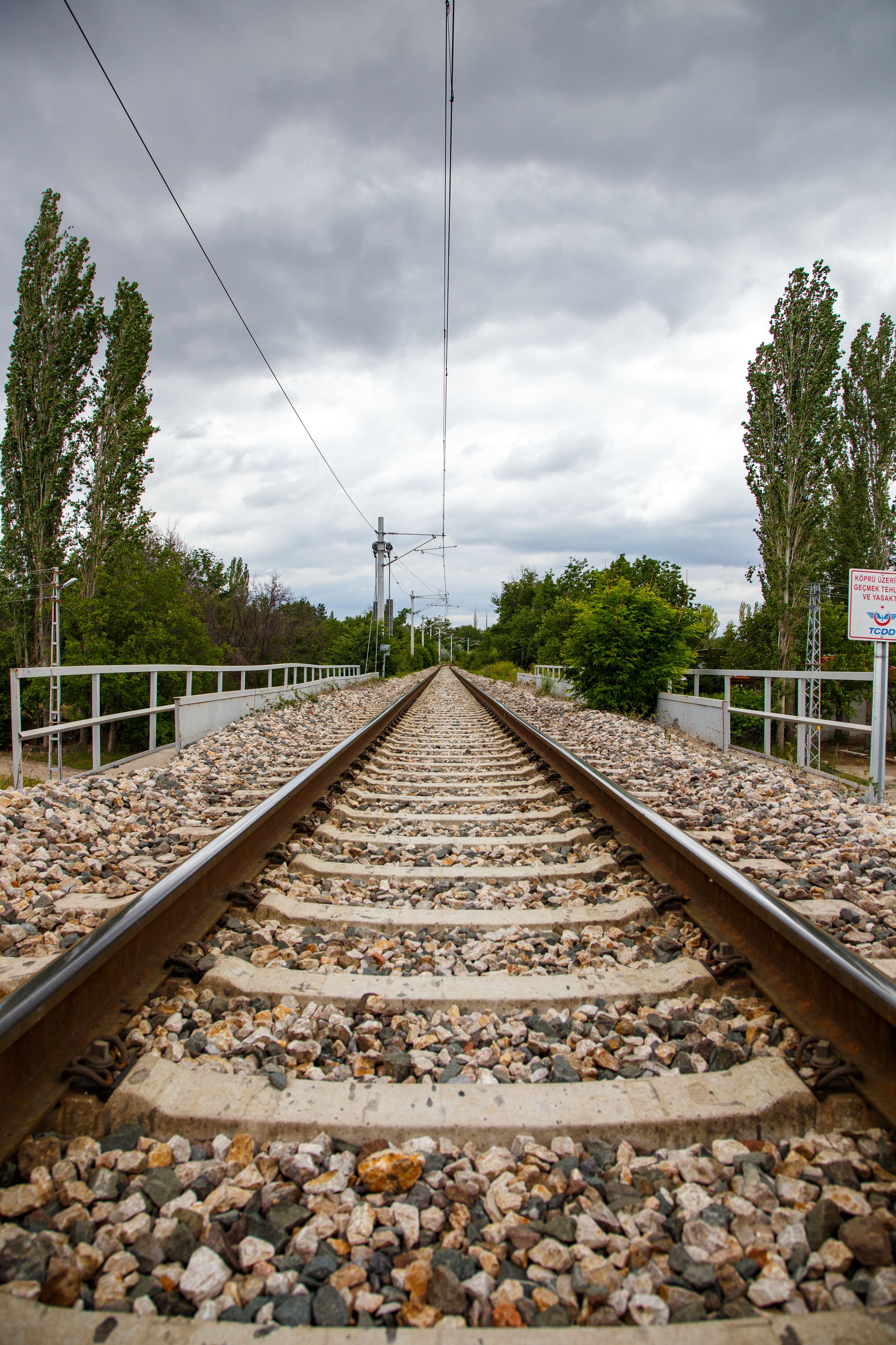 Scenic Railway Tracks Under Cloudy Sky · Free Stock Photo