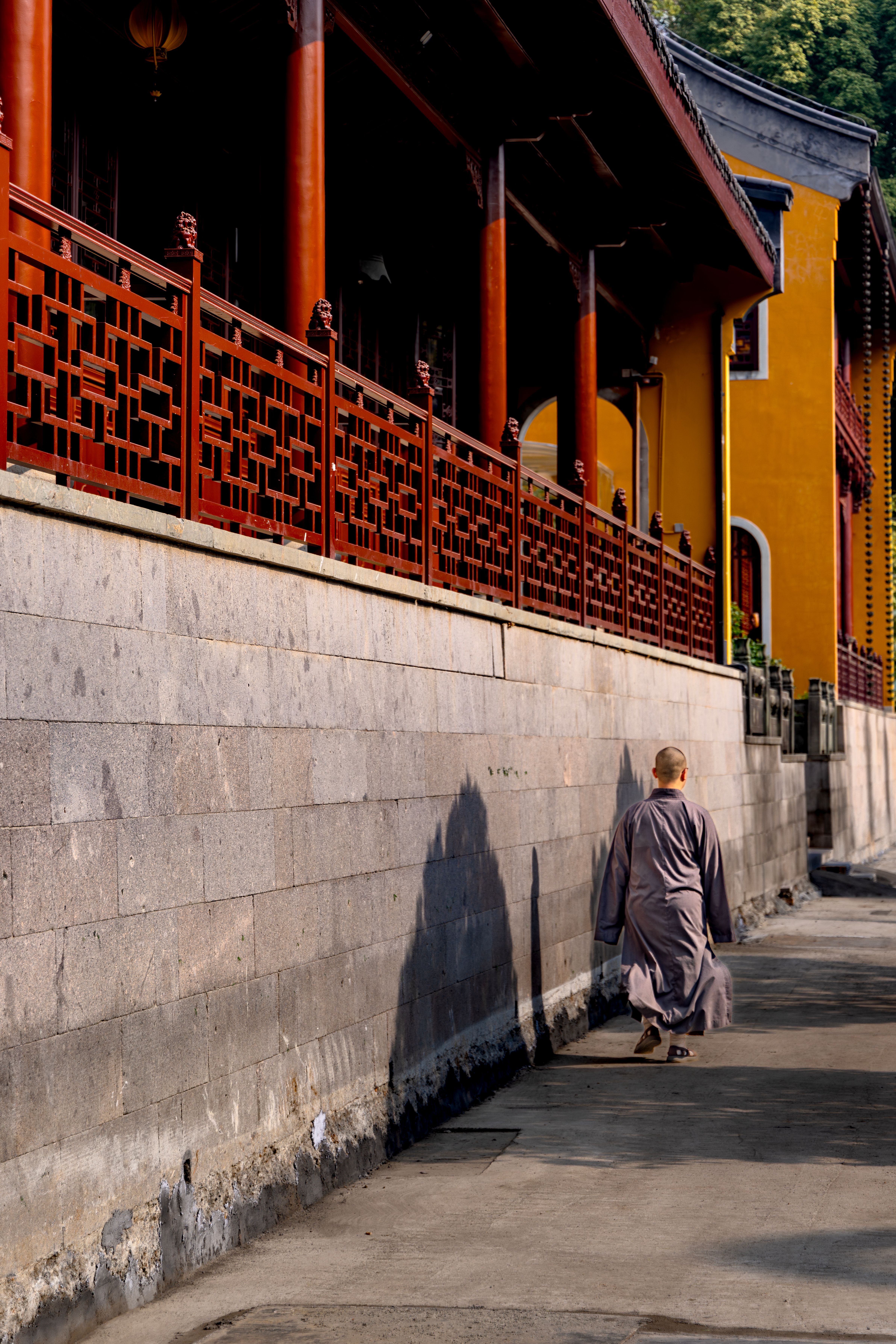 Solitary Monk Walking Past Traditional Temple · Free Stock Photo