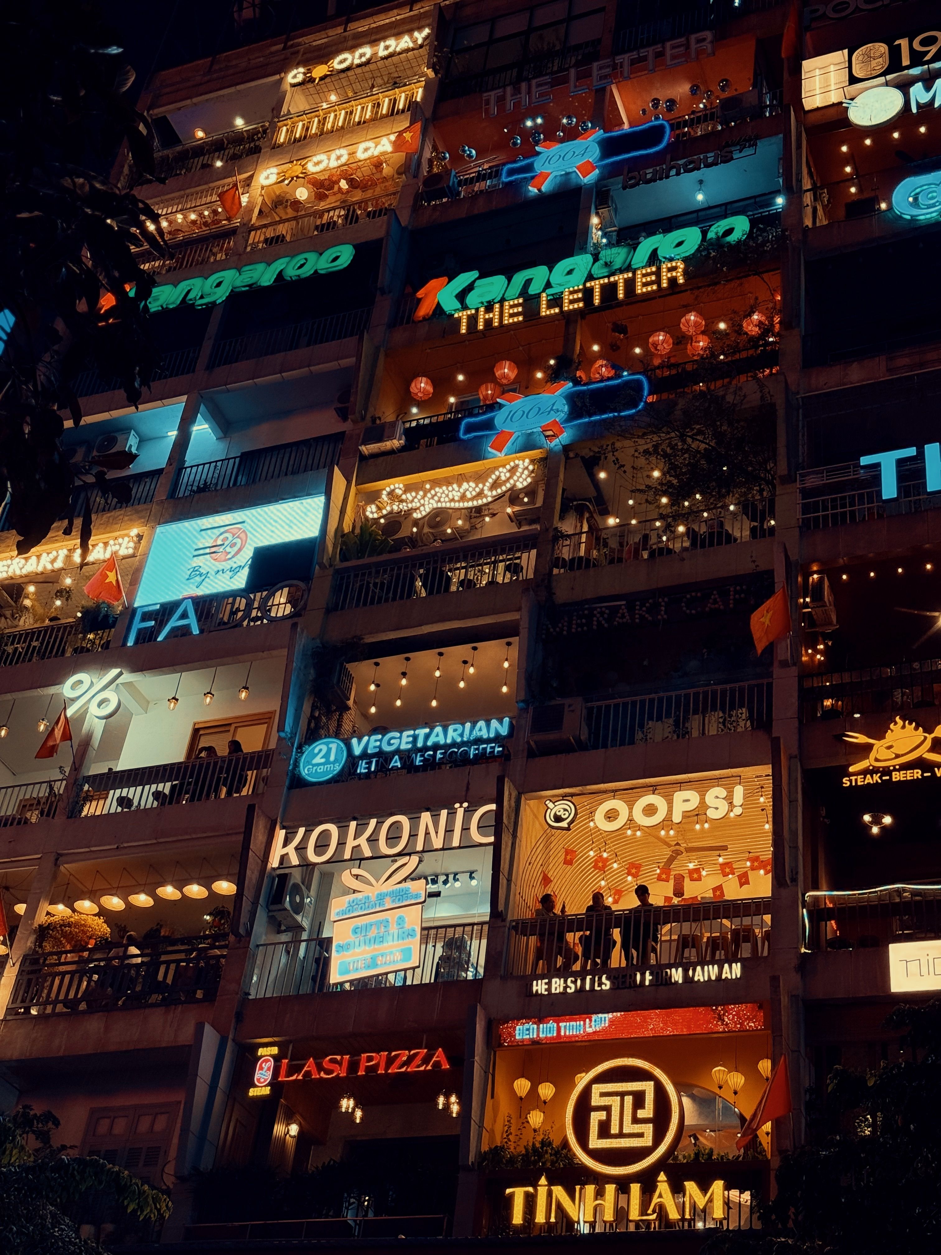 Vibrant Nightlife at Multi-Level Cafe Building · Free Stock Photo