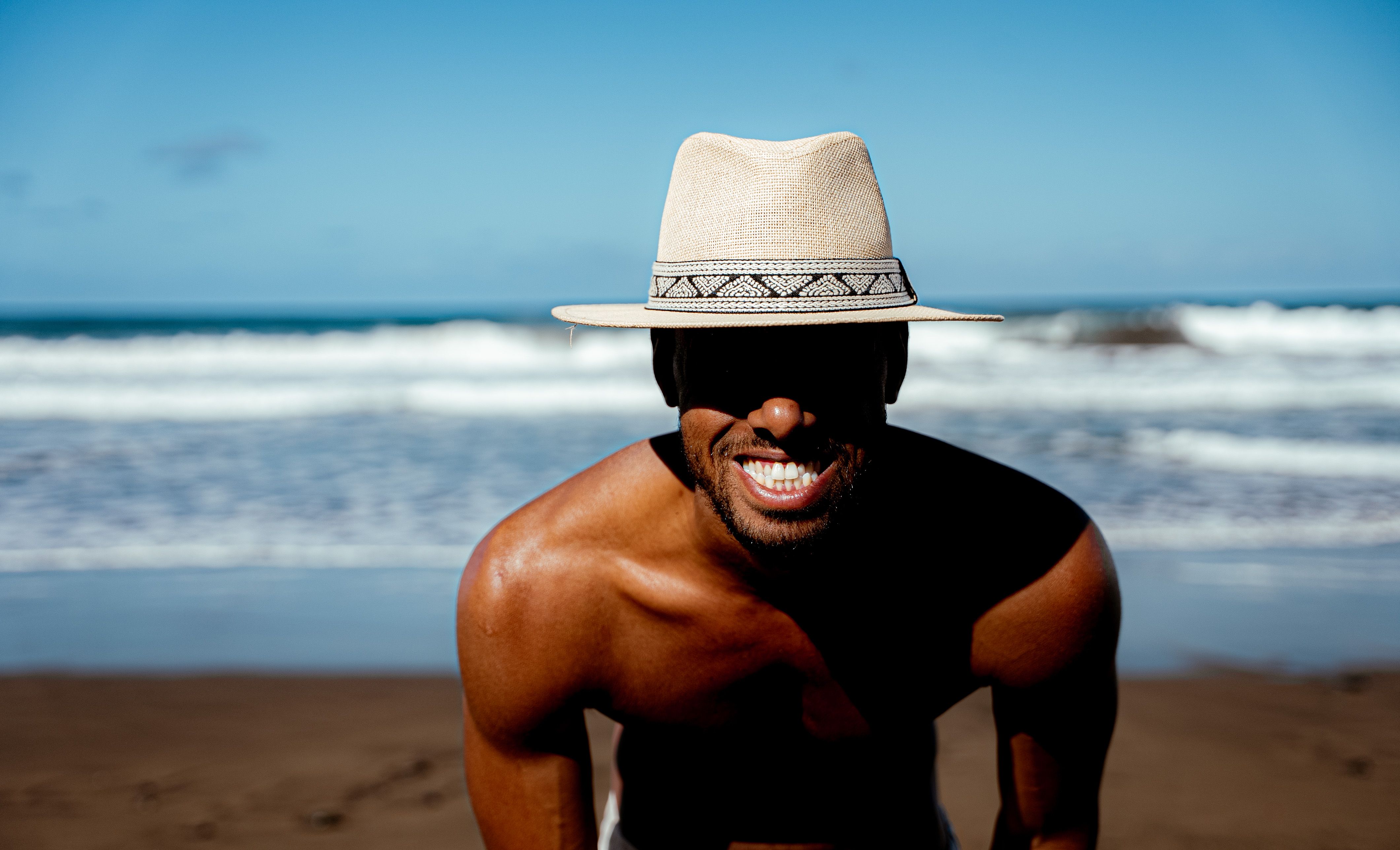 Smiling Man in Sun Hat on Canaries Beach · Free Stock Photo