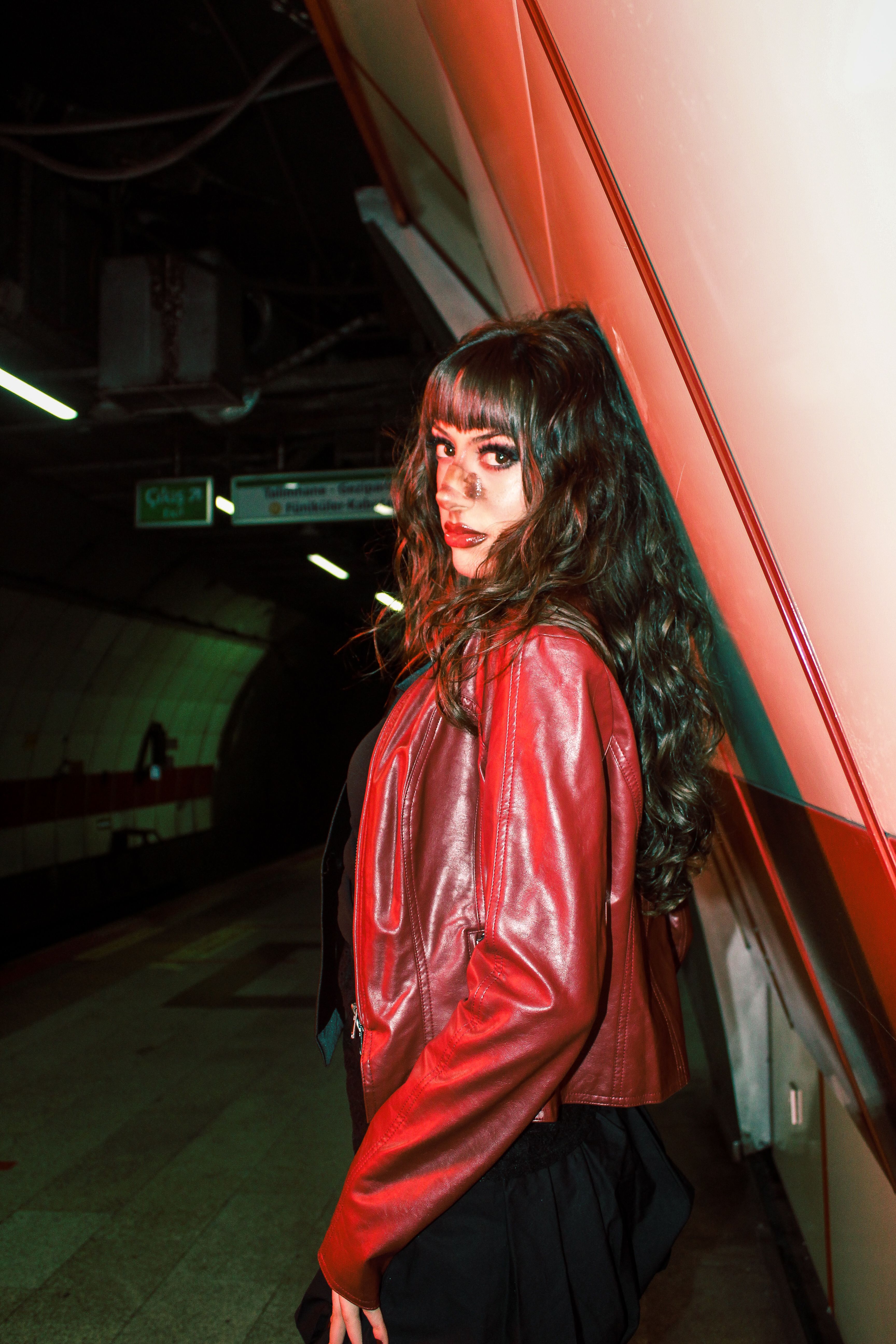 Stylish Woman in Red Jacket at Subway Station · Free Stock Photo