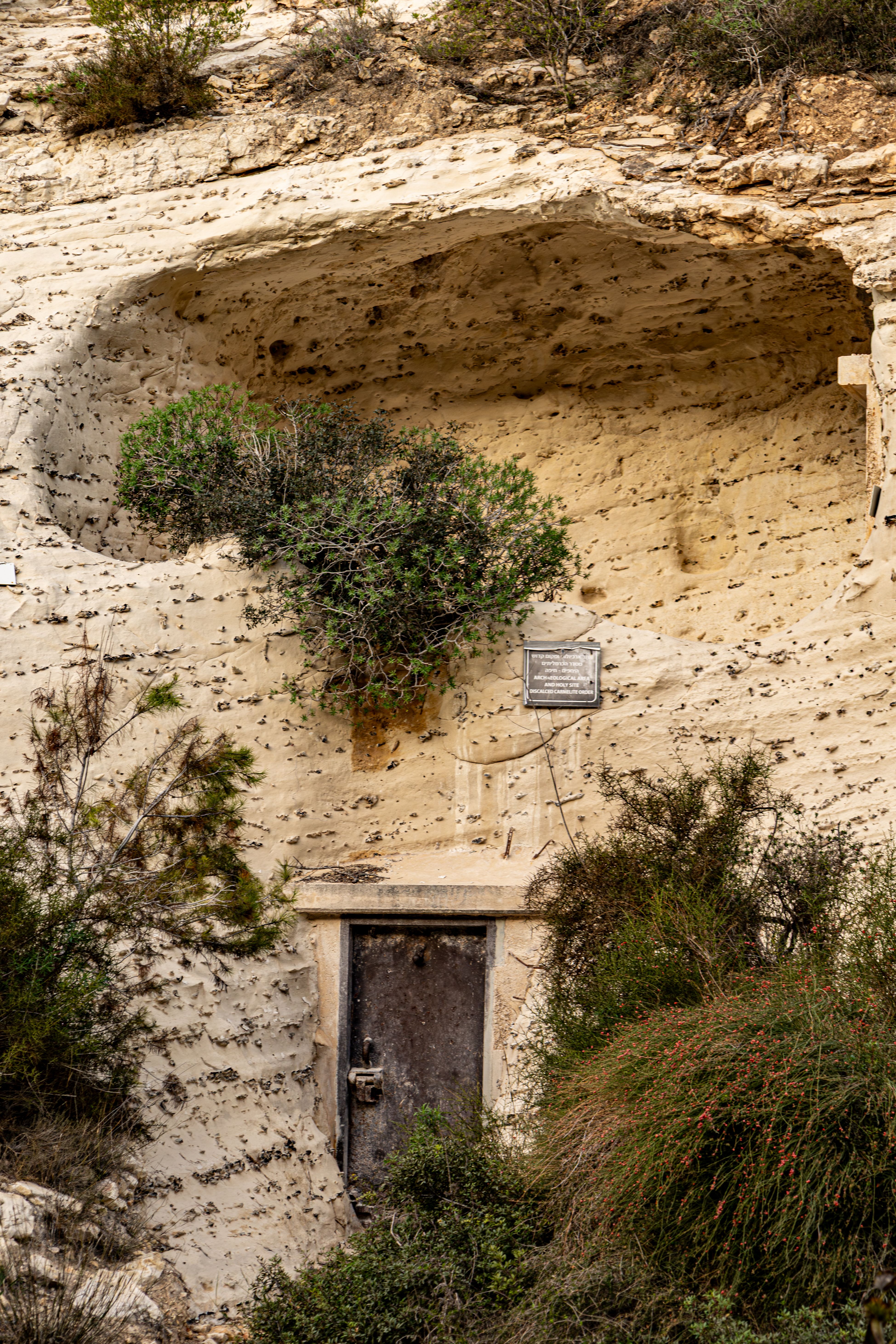 Rustic Door Embedded in Sandy Cliff · Free Stock Photo