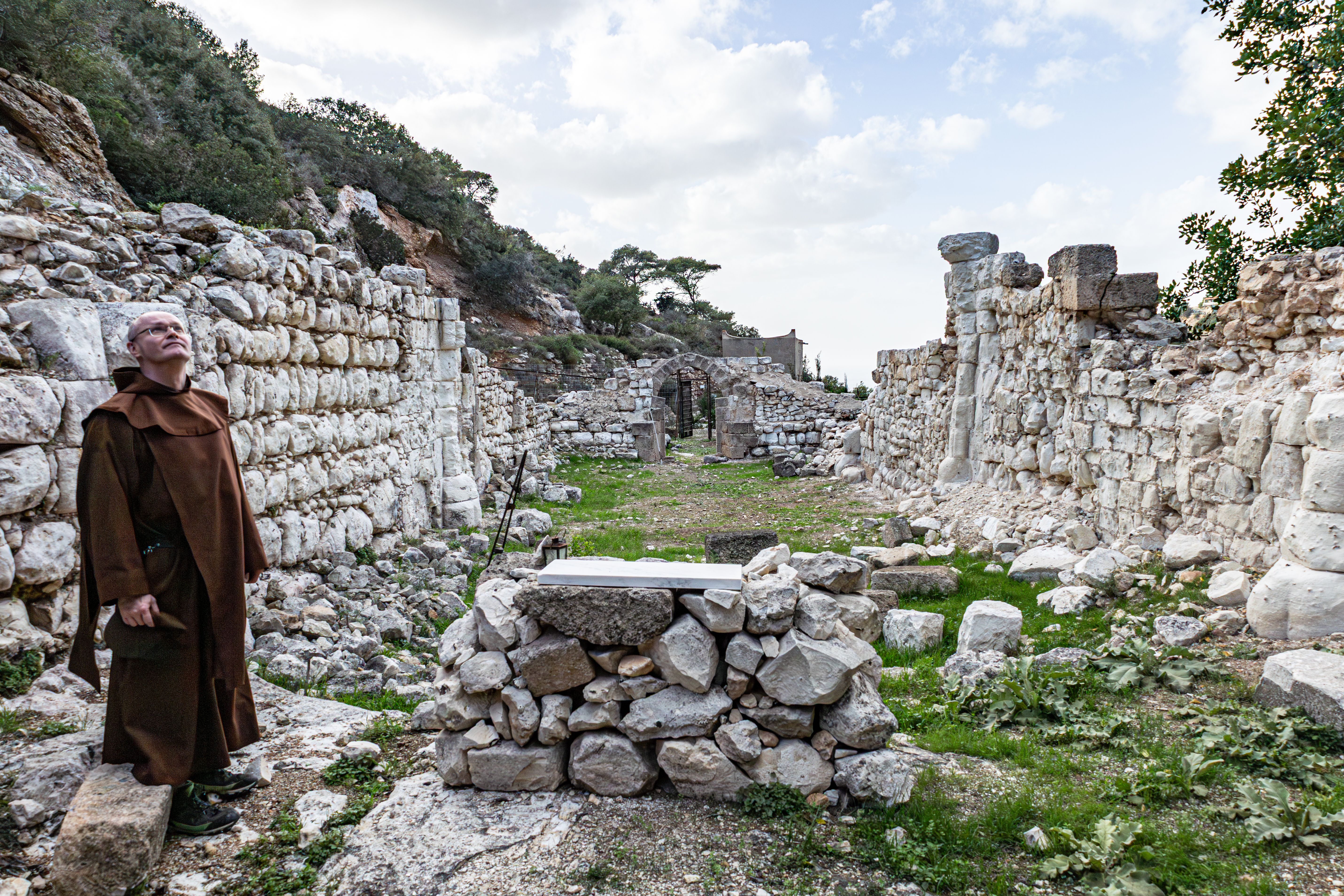 Monk exploring ancient stone ruins outdoors · Free Stock Photo