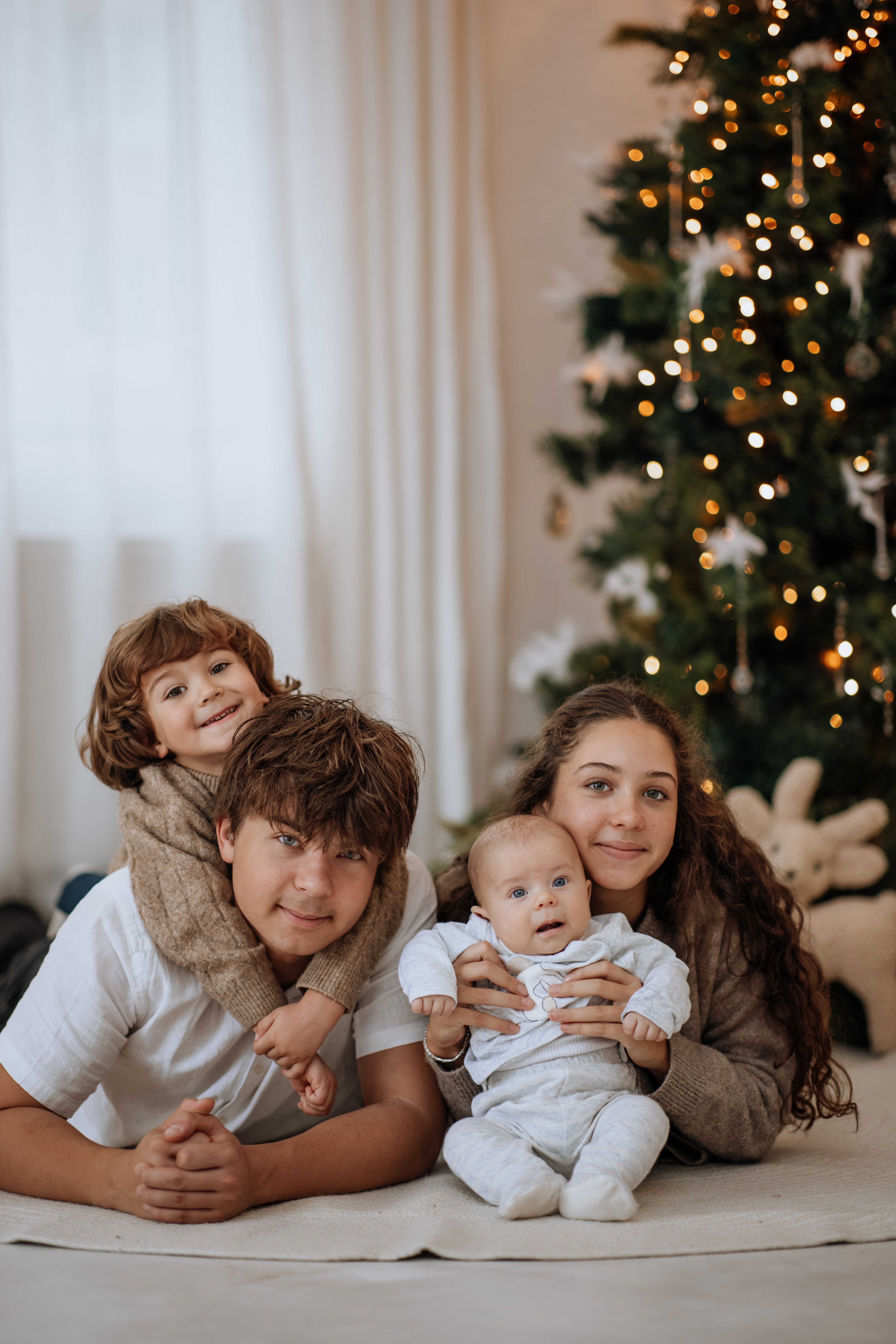 Family Enjoying Festive Christmas Moments Indoors · Free Stock Photo