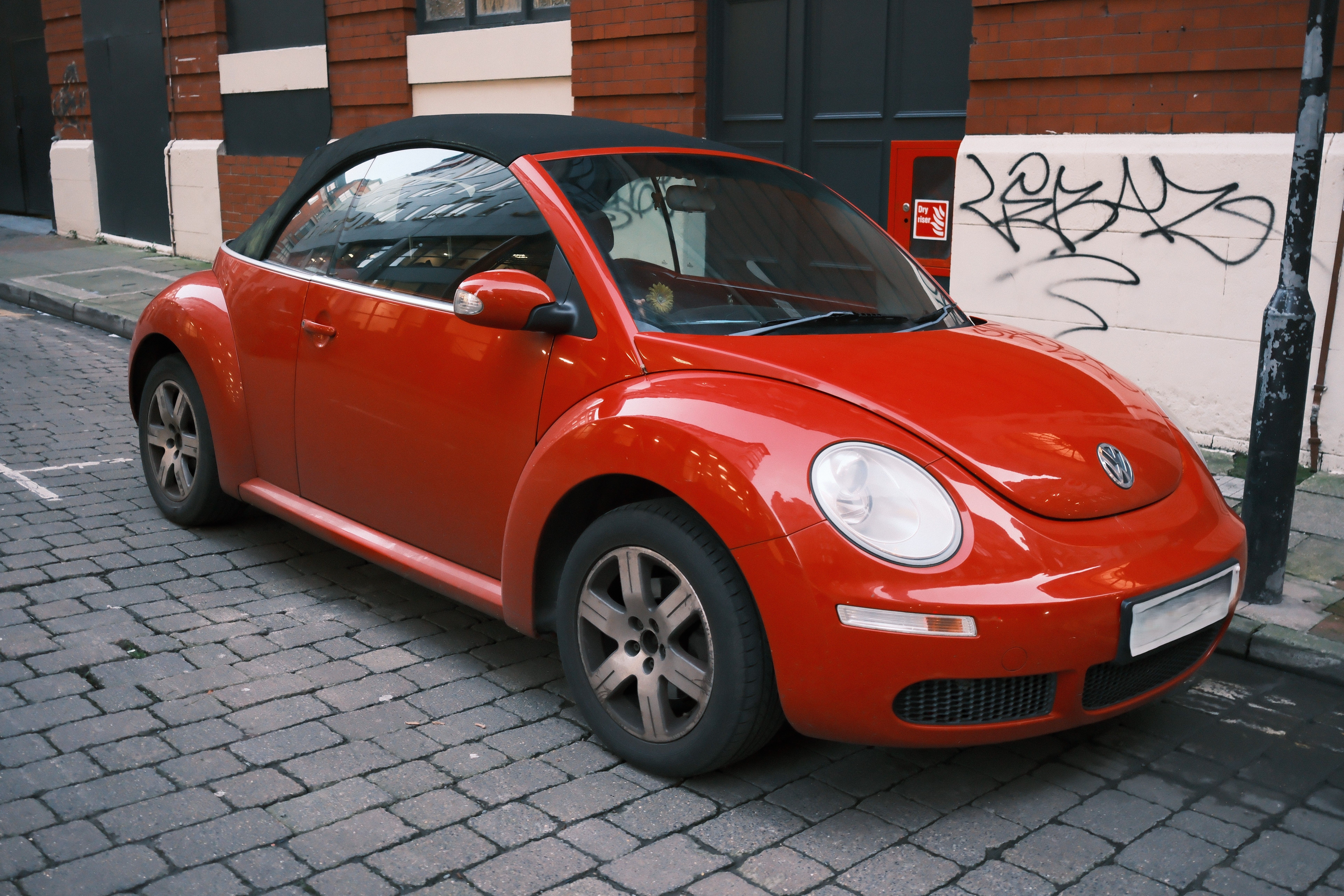Red Compact Car Parked on Urban Street · Free Stock Photo