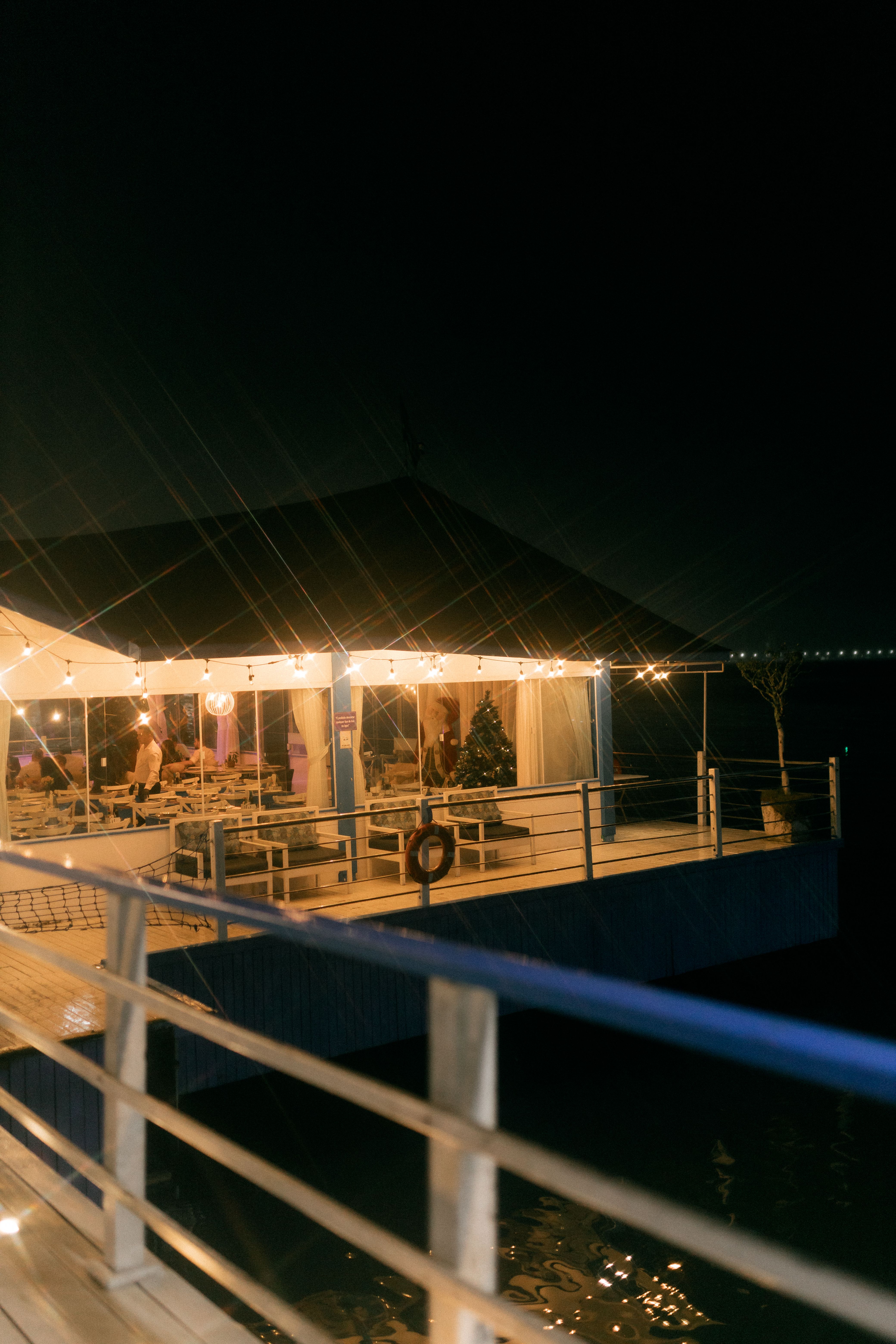 Cozy Waterfront Restaurant Illuminated at Night · Free Stock Photo