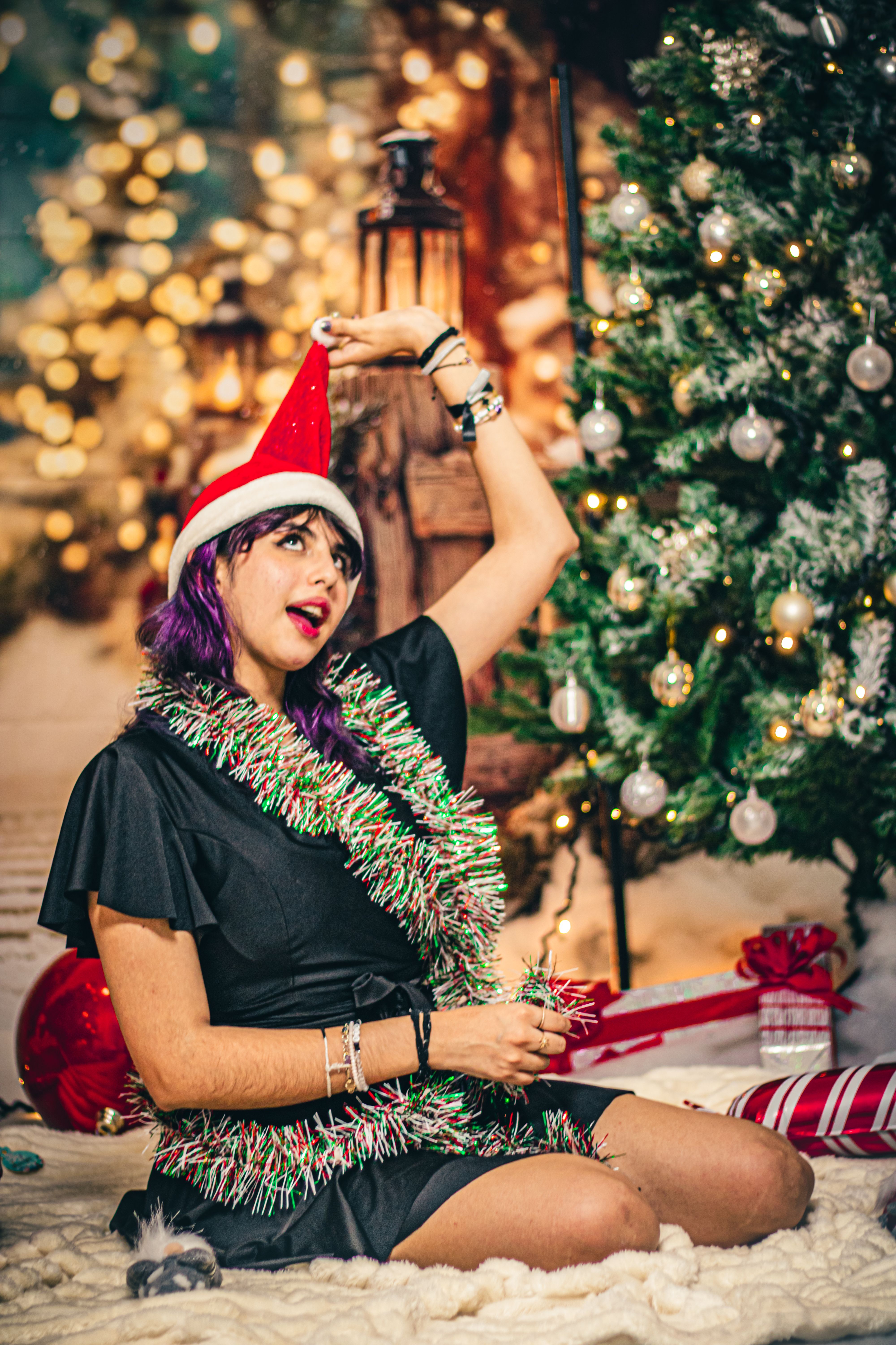 Festive Christmas Scene with Woman and Tree · Free Stock Photo