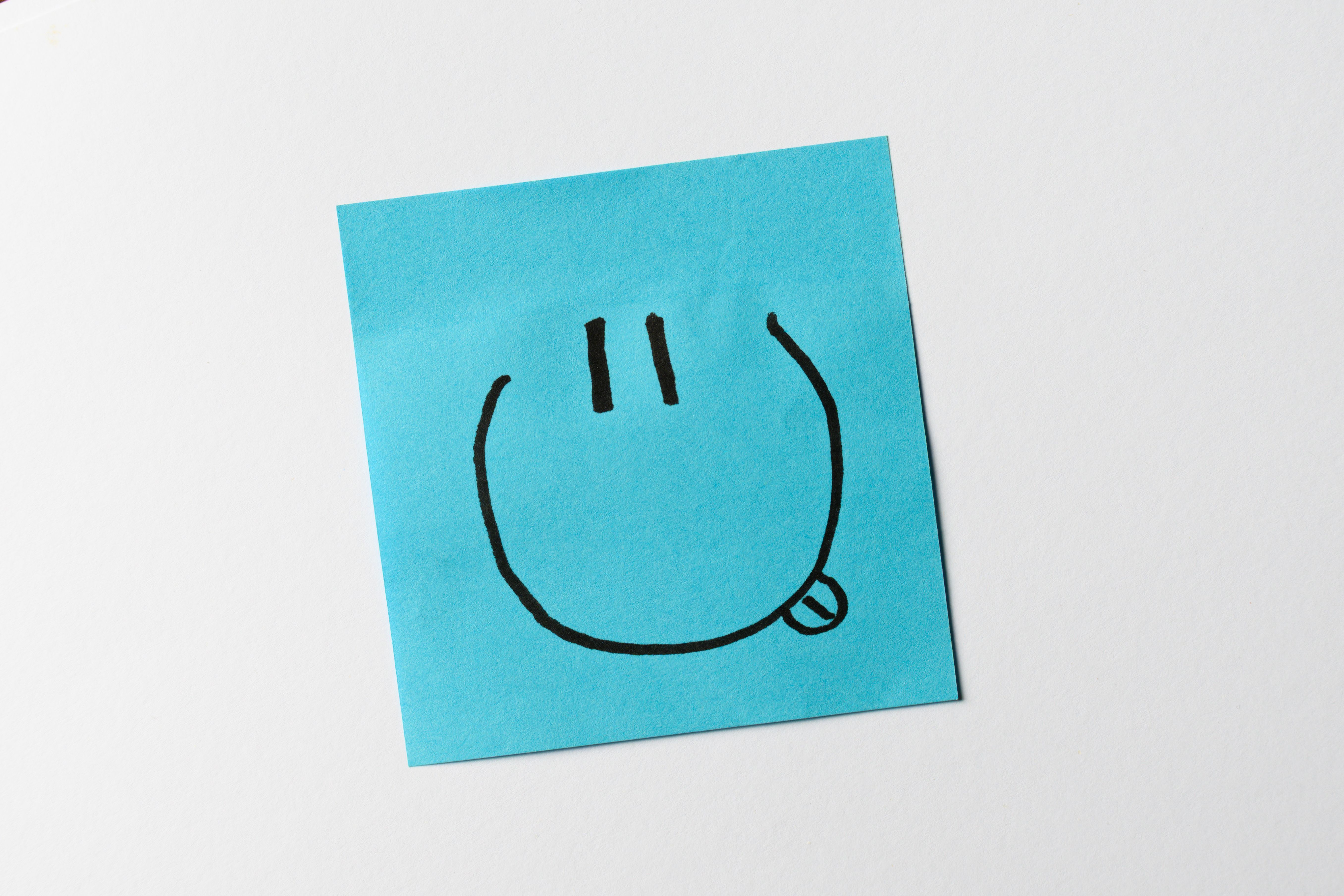 Blue Sticky Note with Smiley Face Drawing · Free Stock Photo
