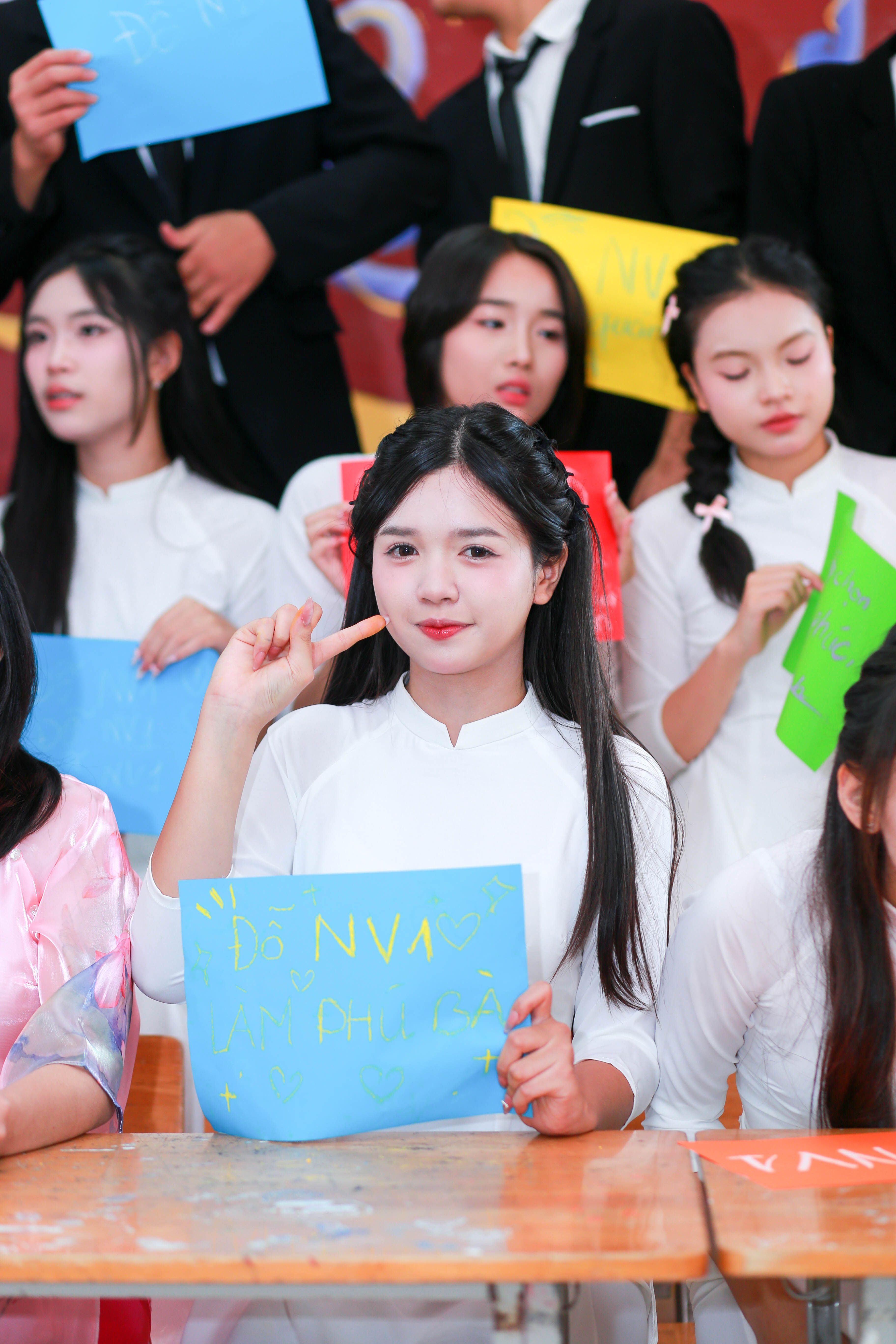 Group of People Holding Colorful Signs Indoors · Free Stock Photo