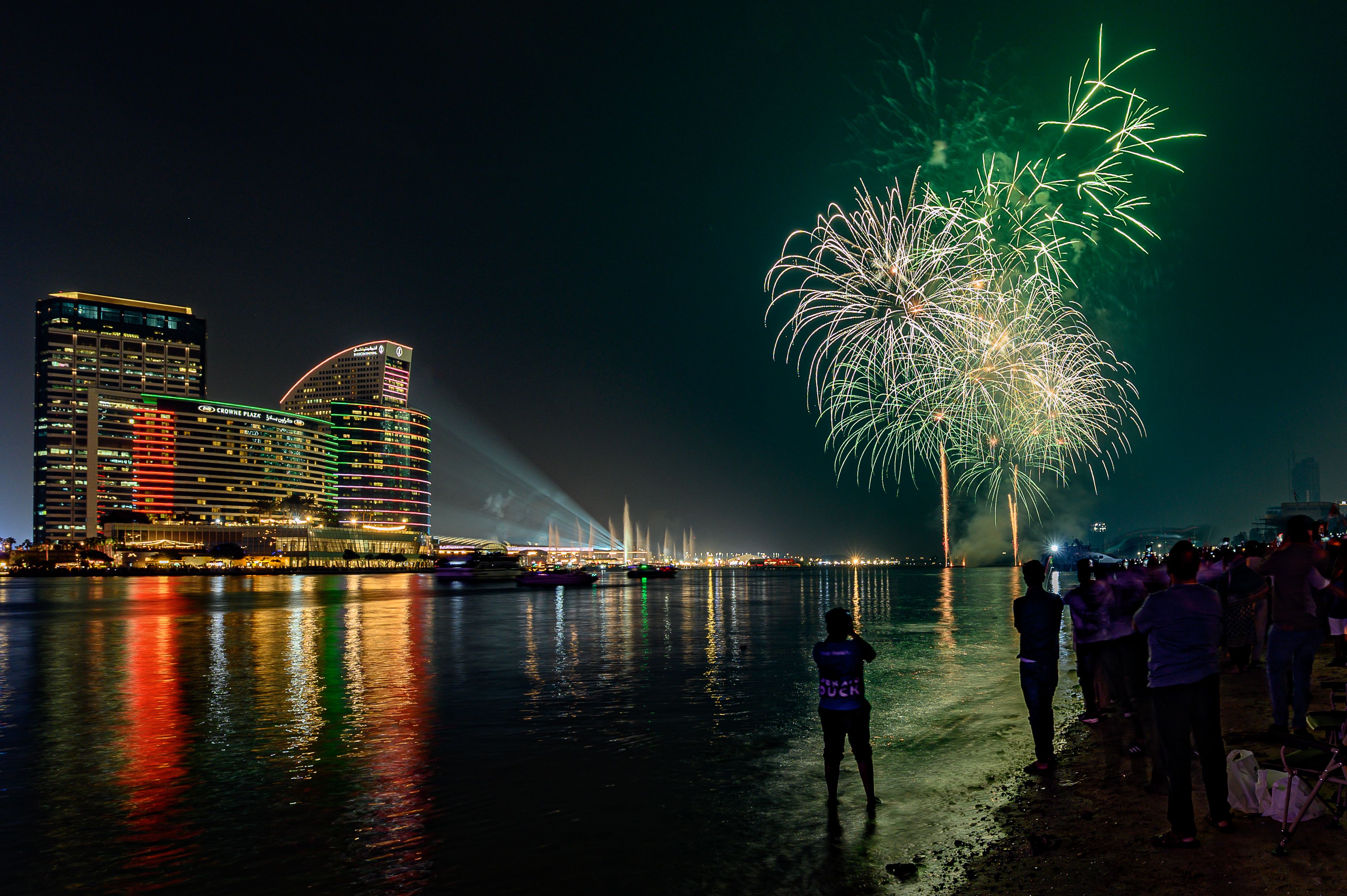 Vibrant Fireworks Display Over City Waterfront · Free Stock Photo