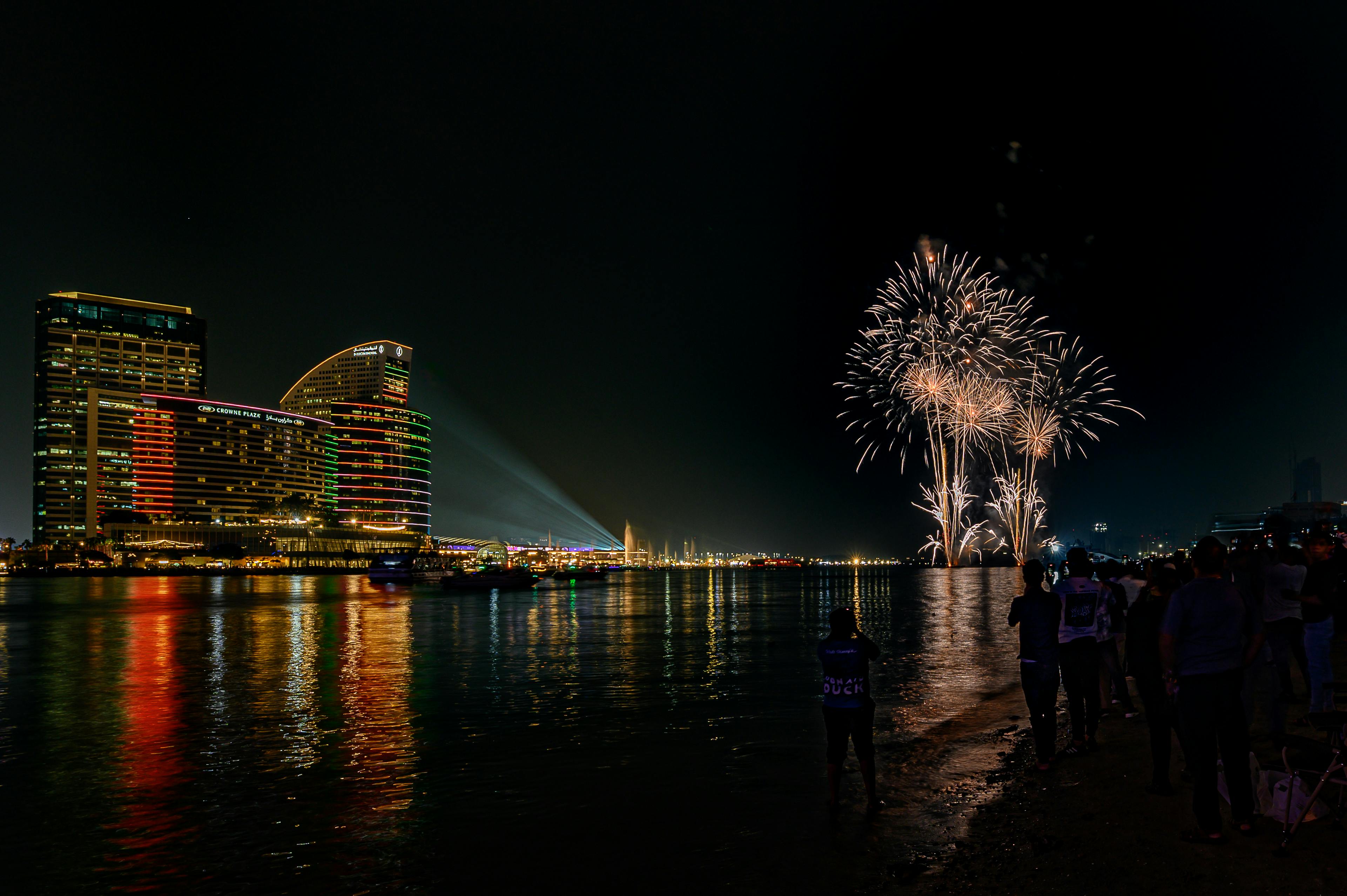 Nighttime Fireworks over City Waterfront Skyline · Free Stock Photo