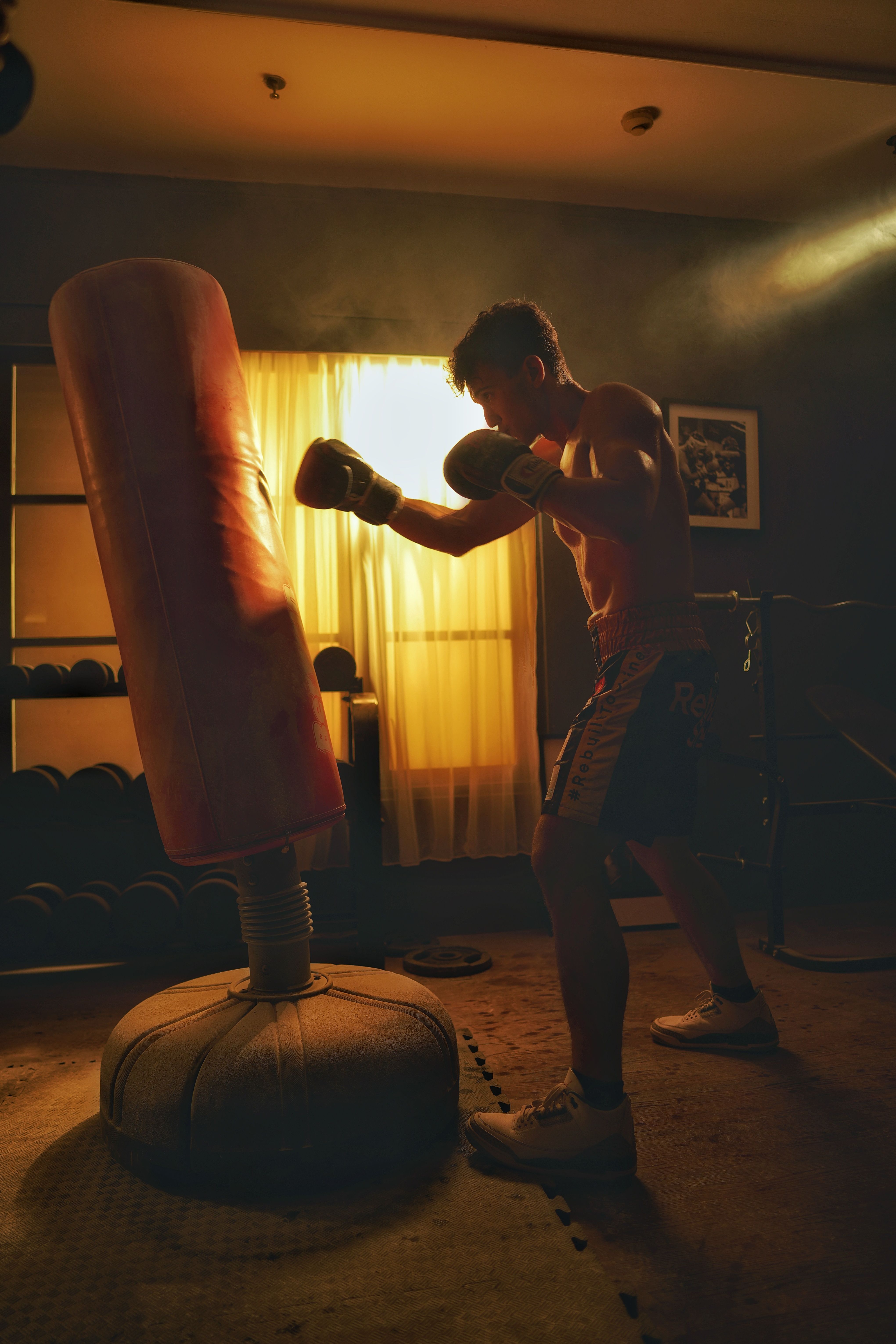 Man Boxing at Home Gym with Punching Bag · Free Stock Photo