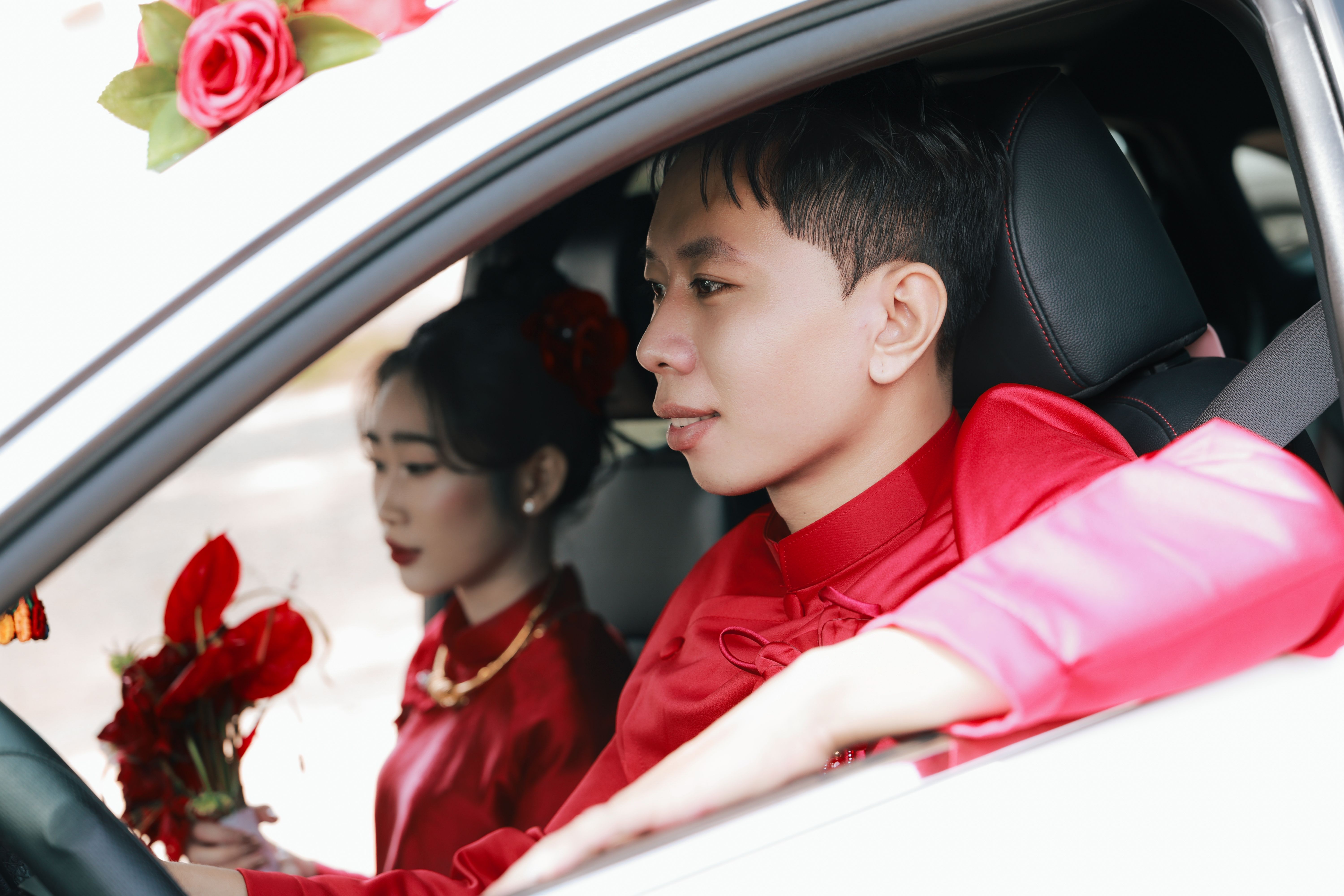 Couple in Traditional Attire in Decorated Car · Free Stock Photo