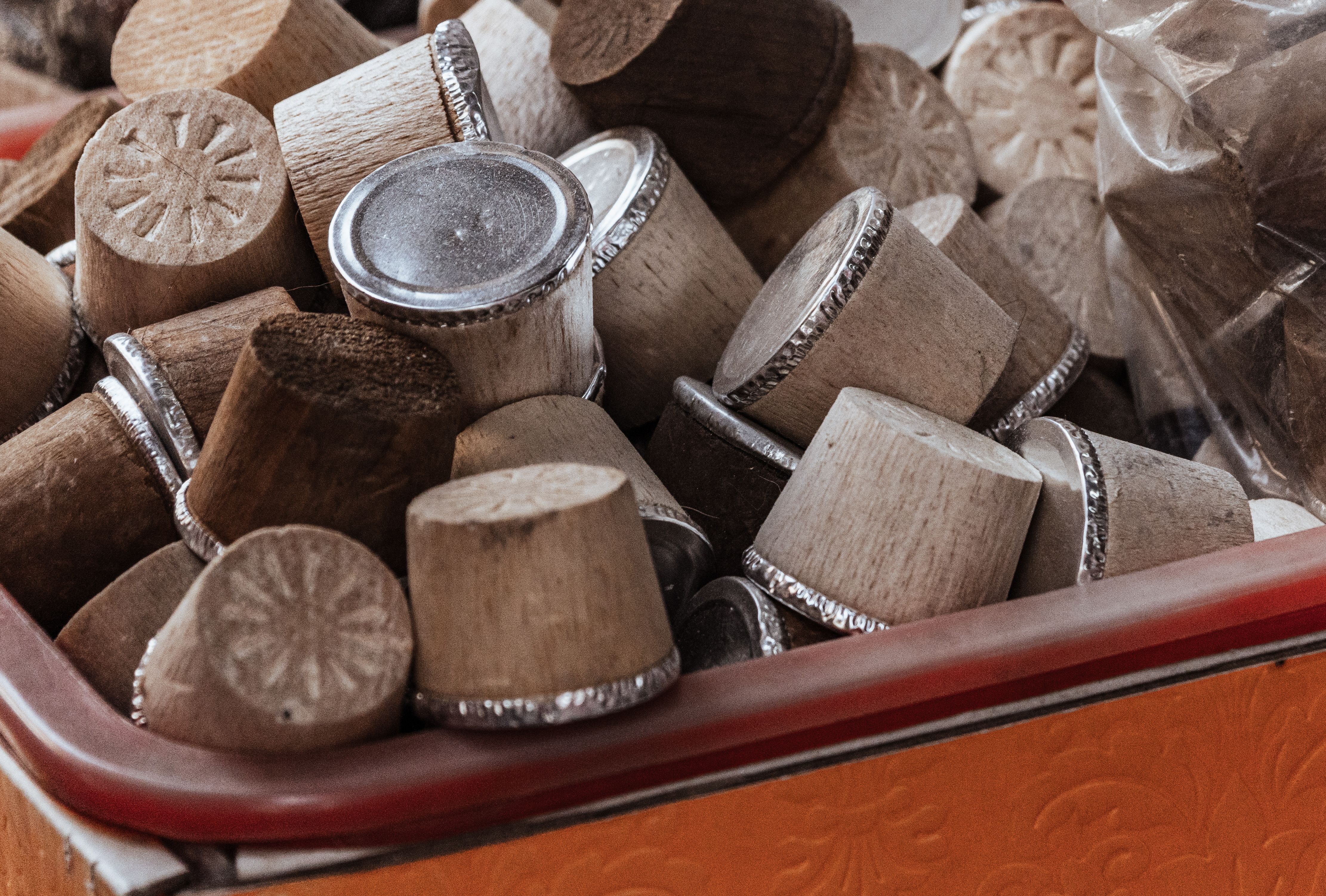 Close-Up of Wooden Bottle Stoppers with Metal Edges · Free Stock Photo