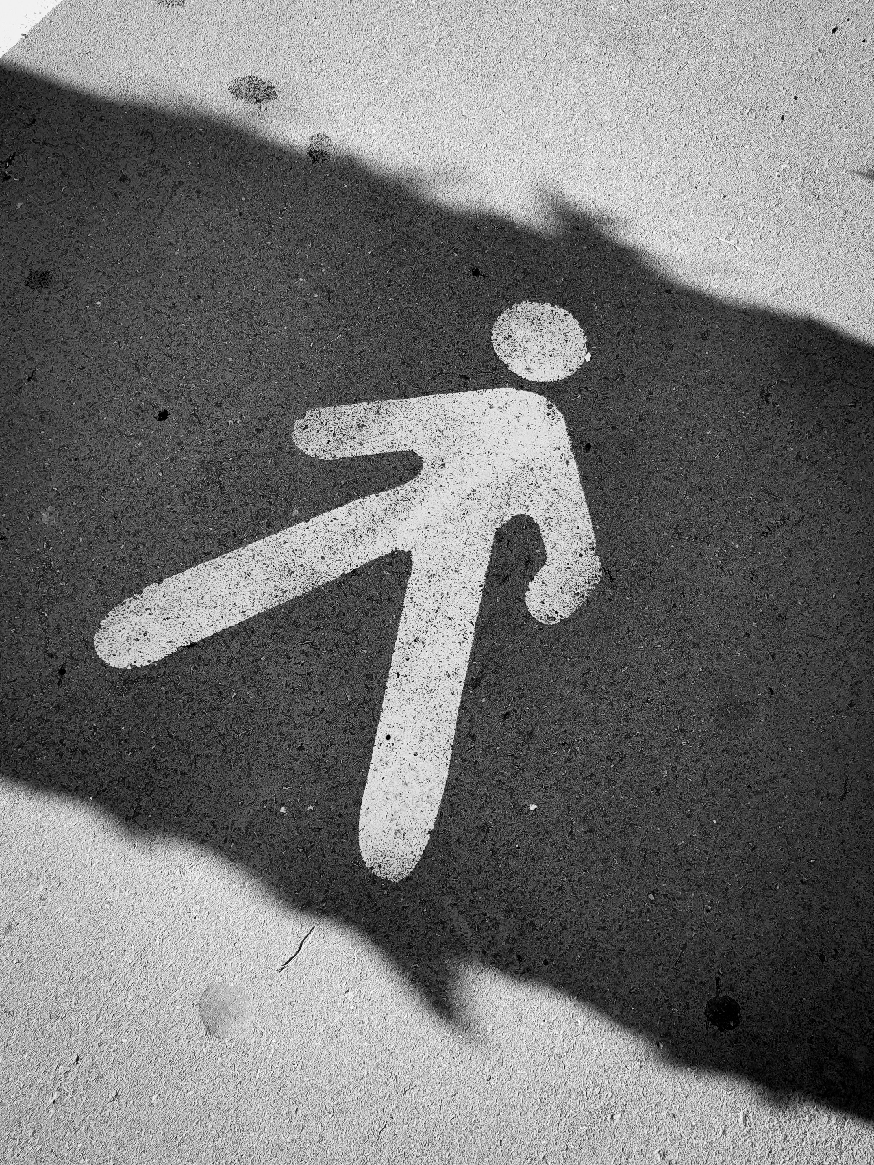 Abstract Shadow Play on Pedestrian Sign · Free Stock Photo