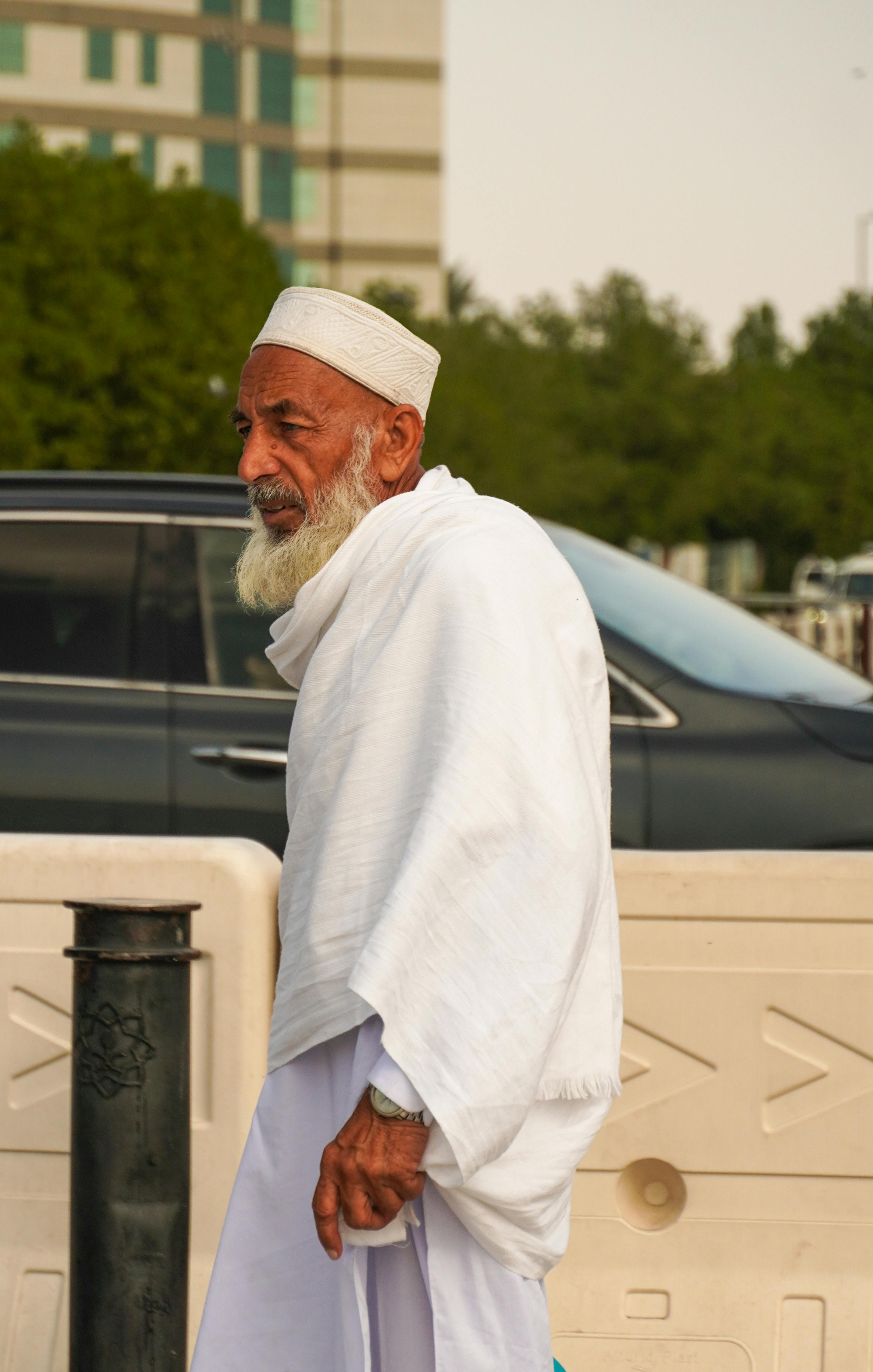 Elderly Man Walking in Traditional Islamic Attire · Free Stock Photo