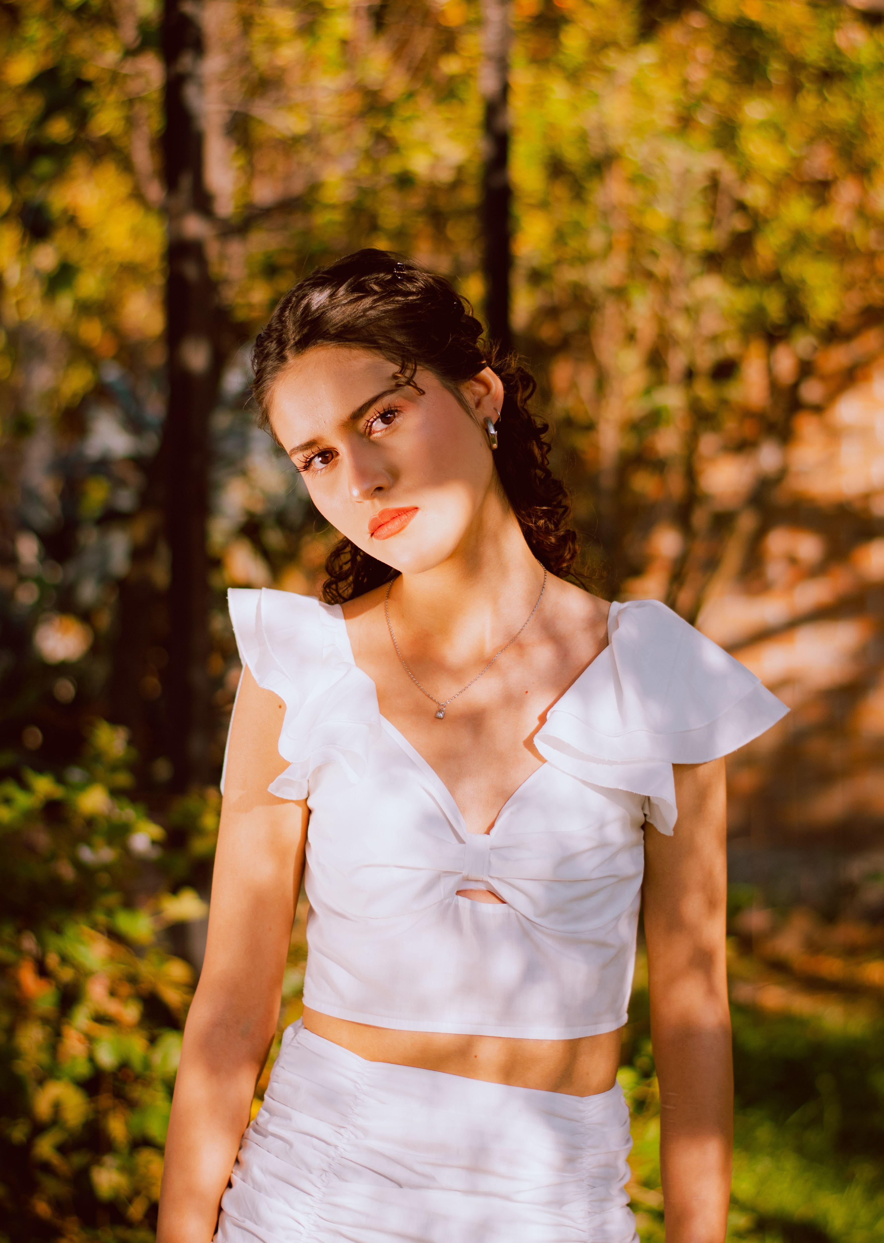 Young Woman in Sunlit Garden Portrait · Free Stock Photo