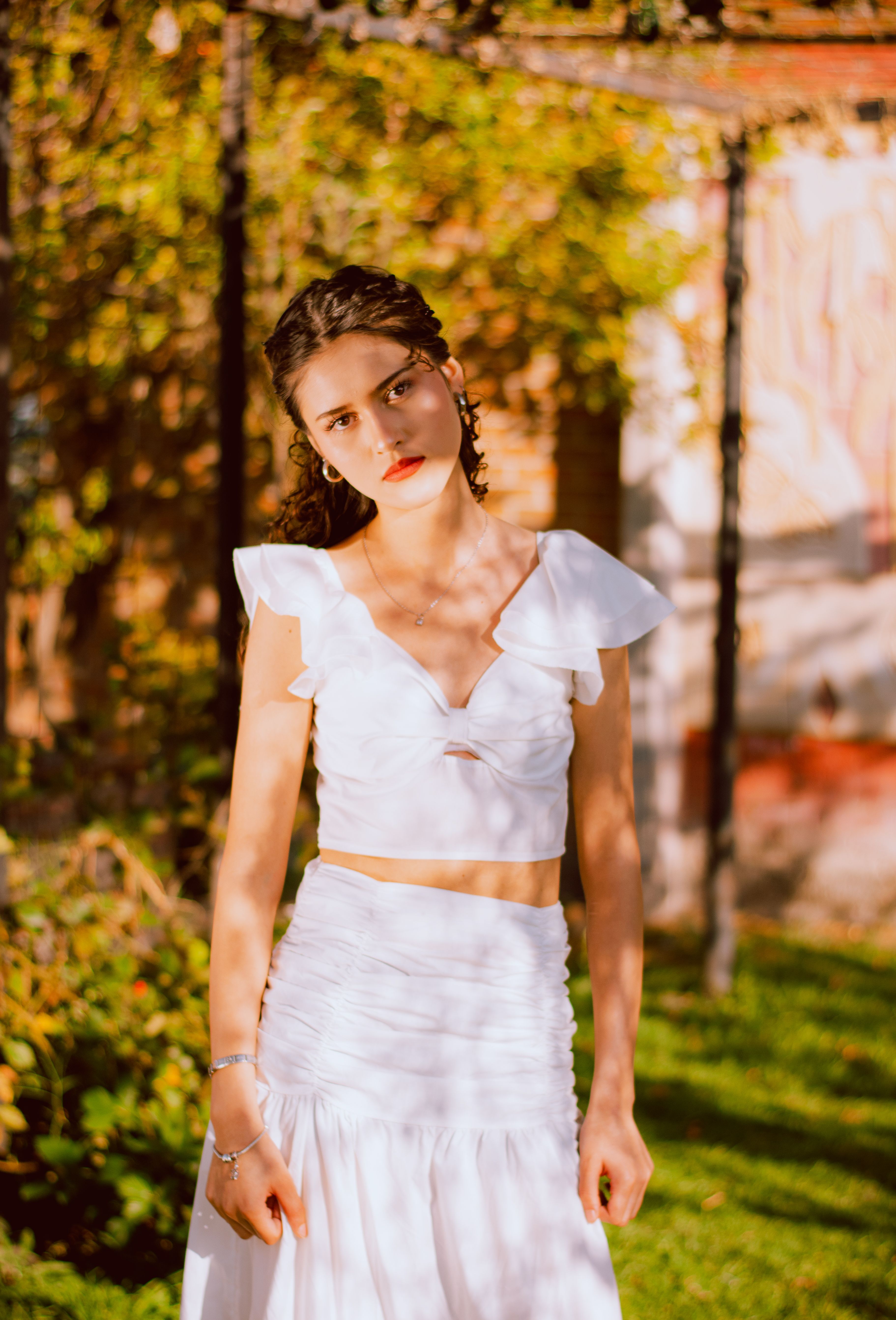 Young Woman in Sunlit Garden Portrait · Free Stock Photo