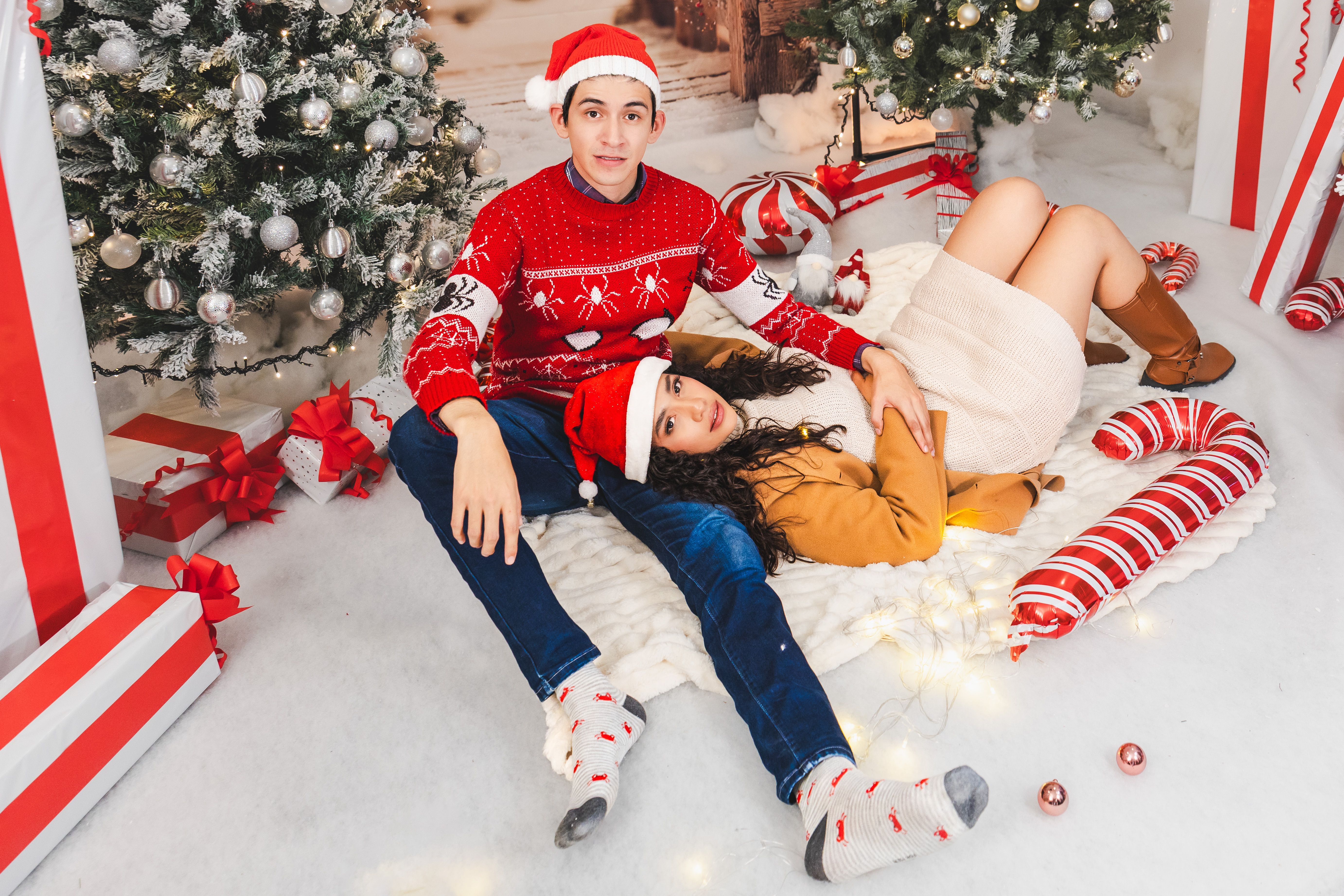 Festive Holiday Couple in Cozy Christmas Setting · Free Stock Photo