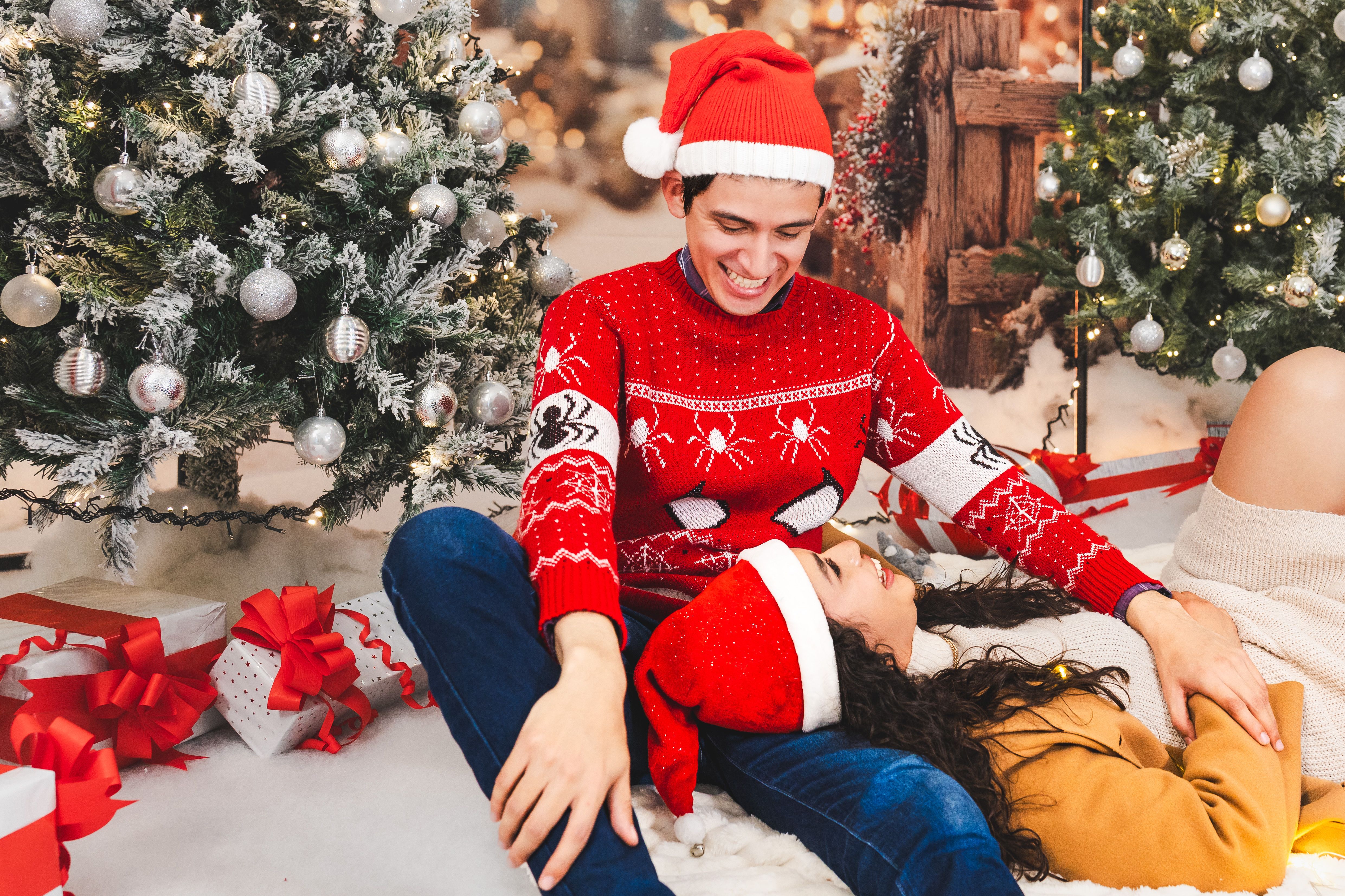 Happy Couple by Christmas Tree with Gifts · Free Stock Photo