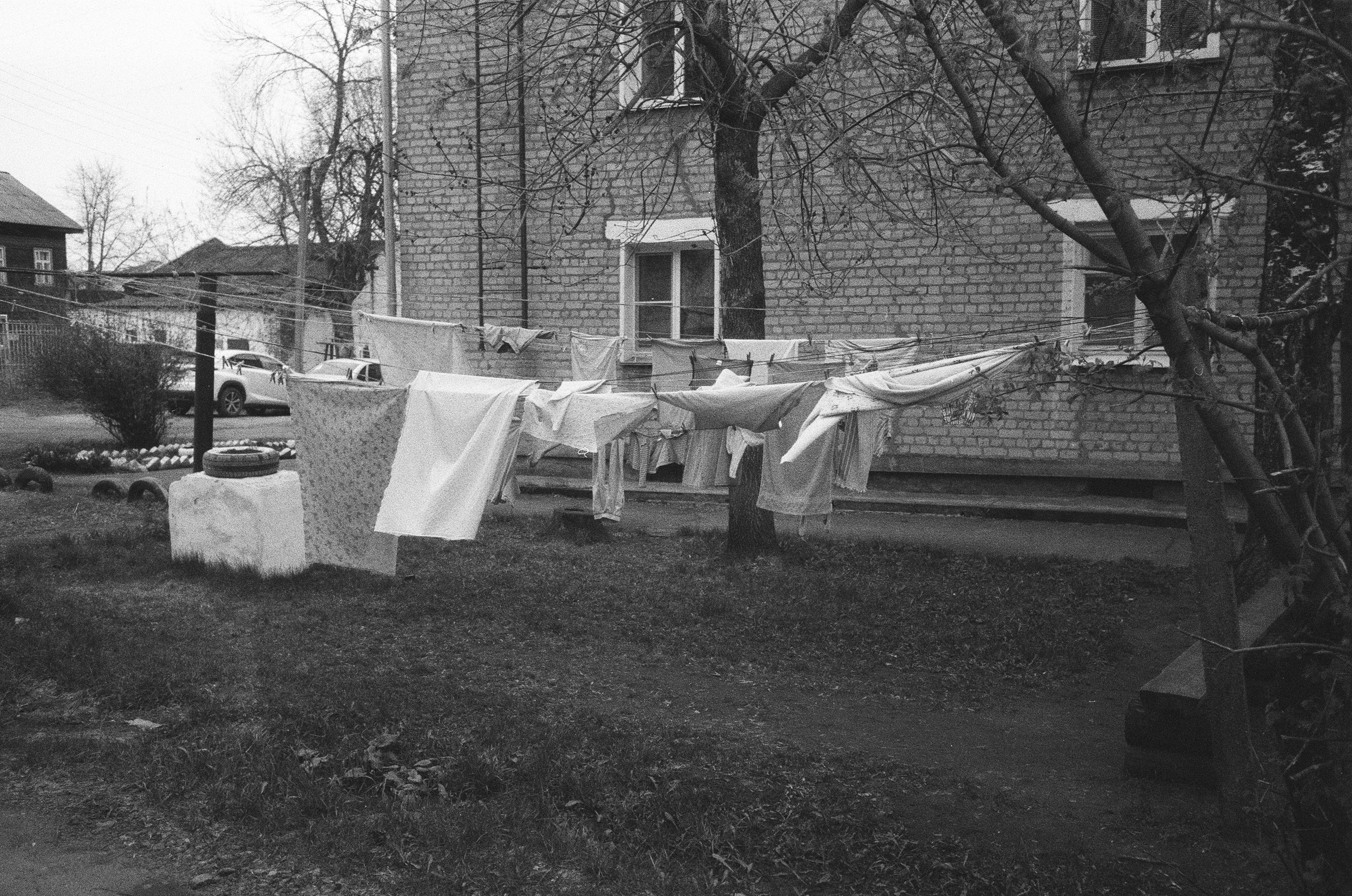 Monochrome Laundry Hanging in Backyard Scene · Free Stock Photo
