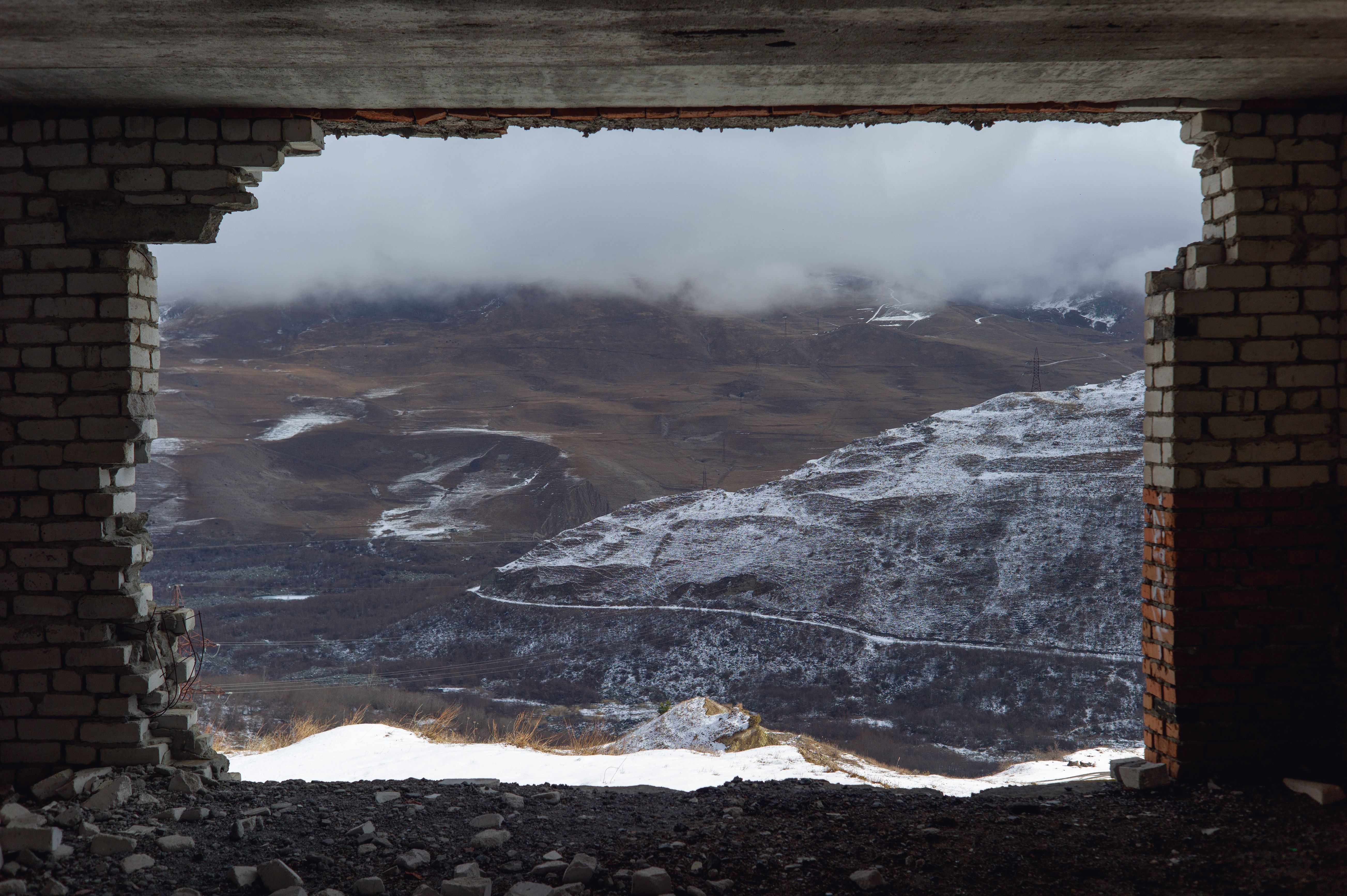 Breathtaking Mountain View Through Ruined Wall · Free Stock Photo