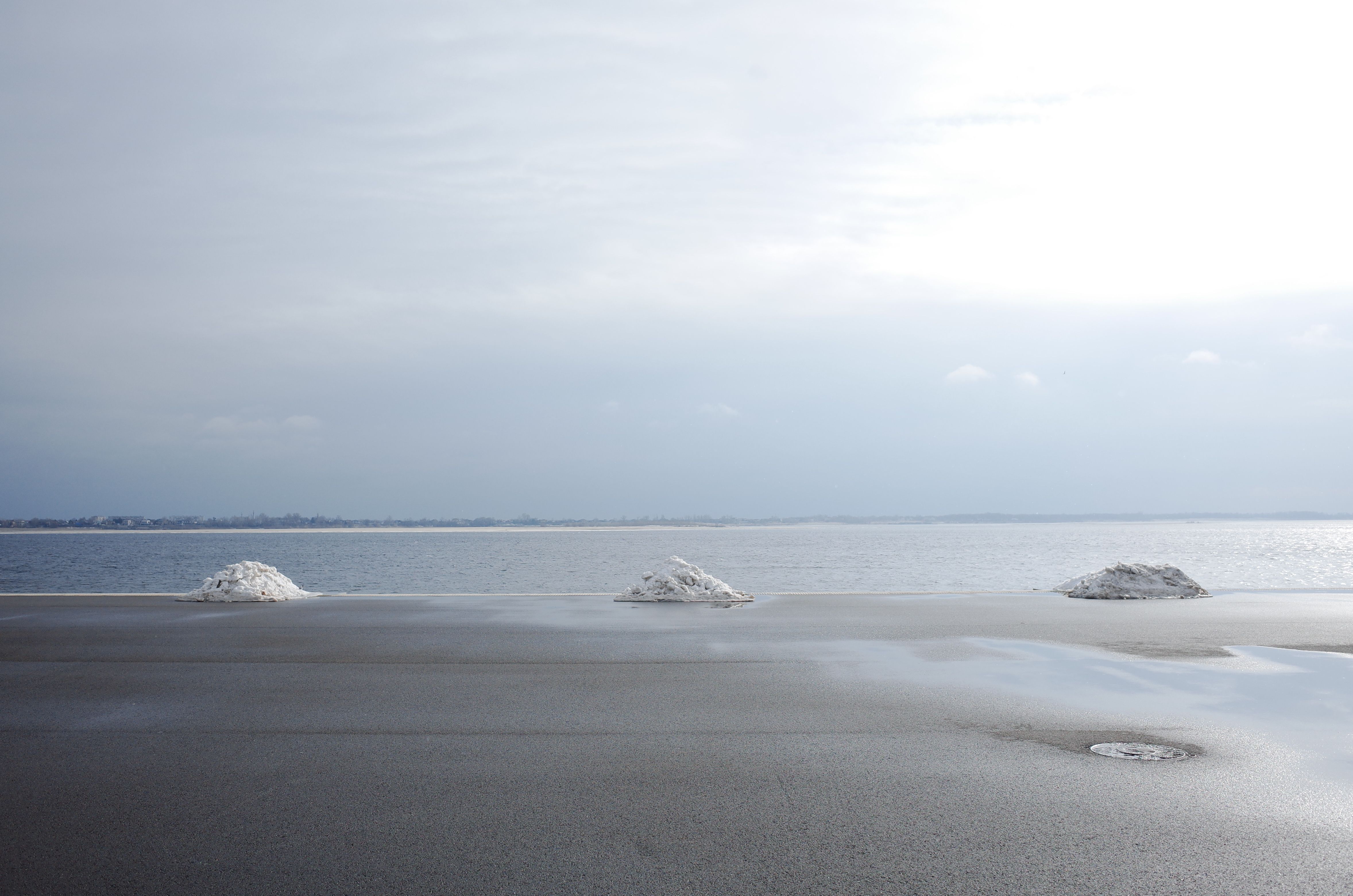 Serene Winter Seaside with Snow Piles · Free Stock Photo