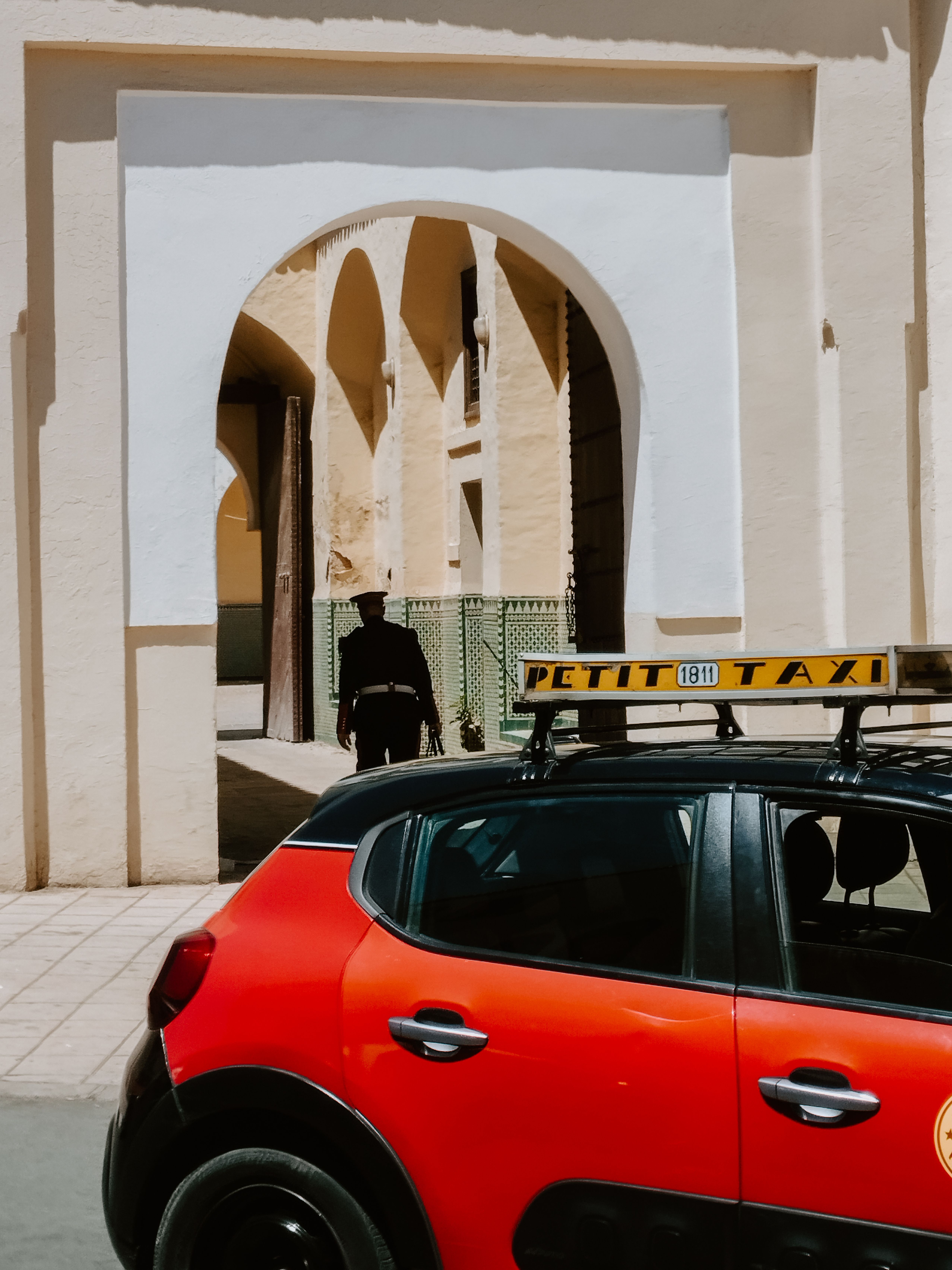 Street Scene in Fes Medina with Red Taxi · Free Stock Photo