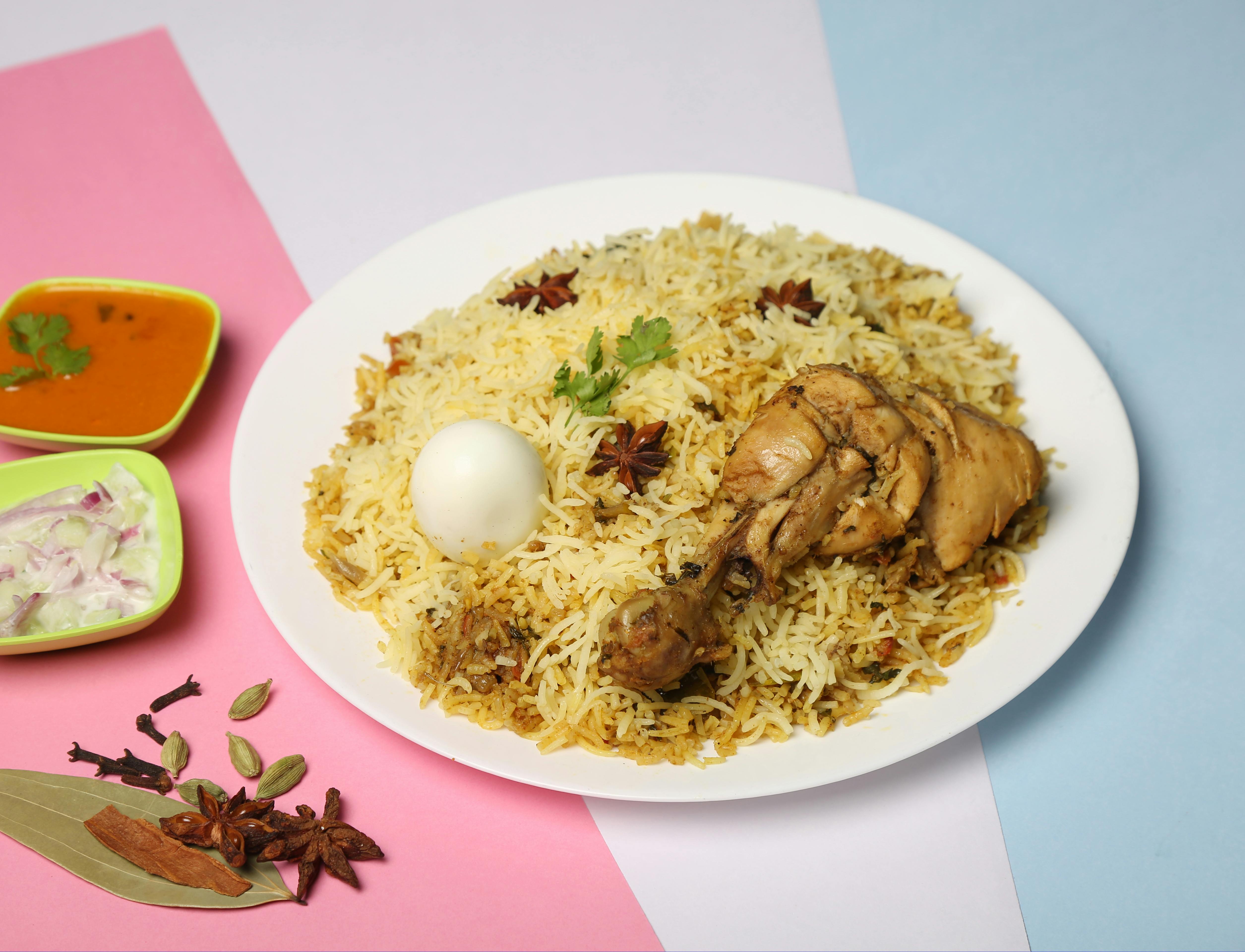Delicious Chicken Biryani with Sides on Plate · Free Stock Photo