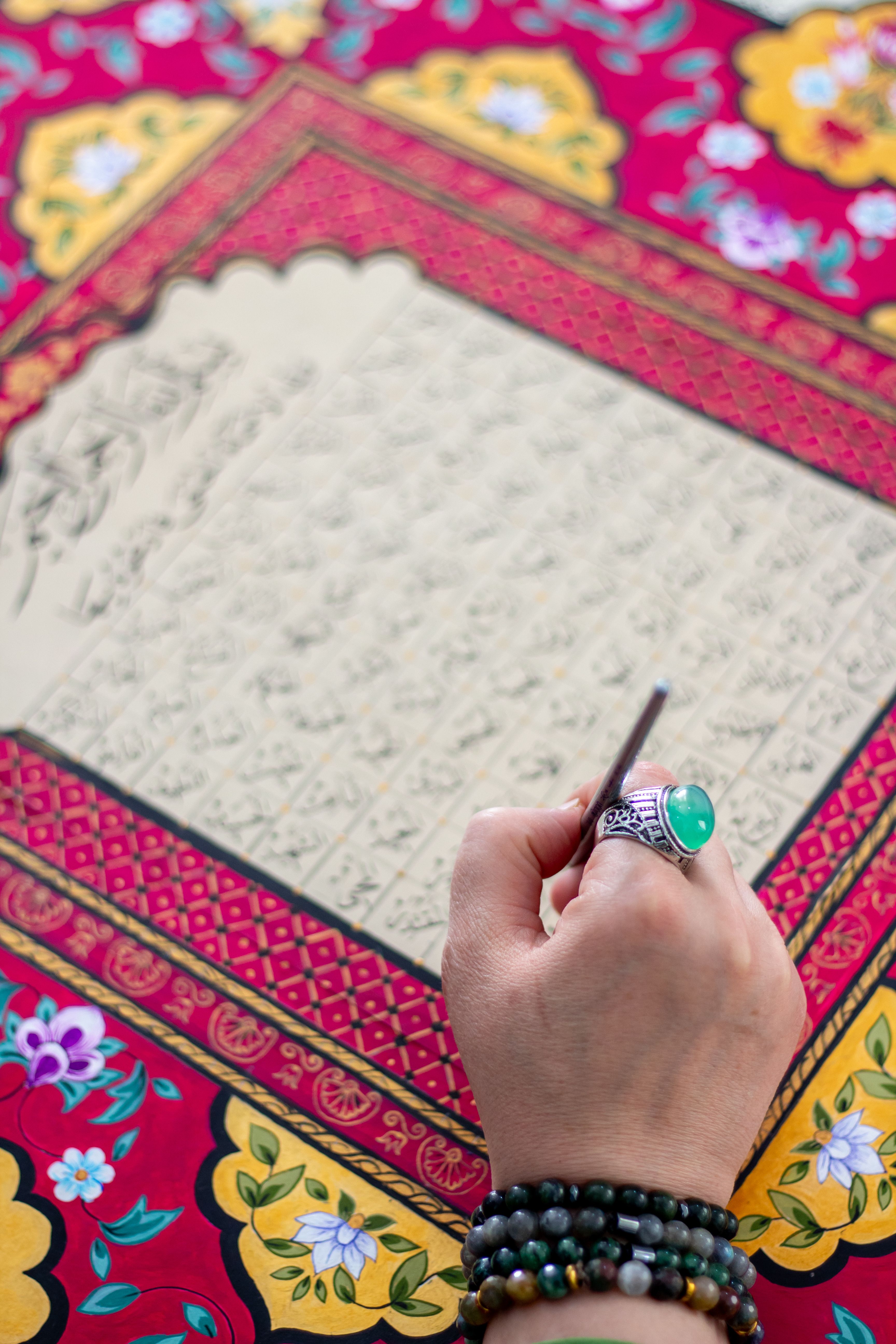 Intricate Calligraphy on Vibrant Fabric Canvas · Free Stock Photo