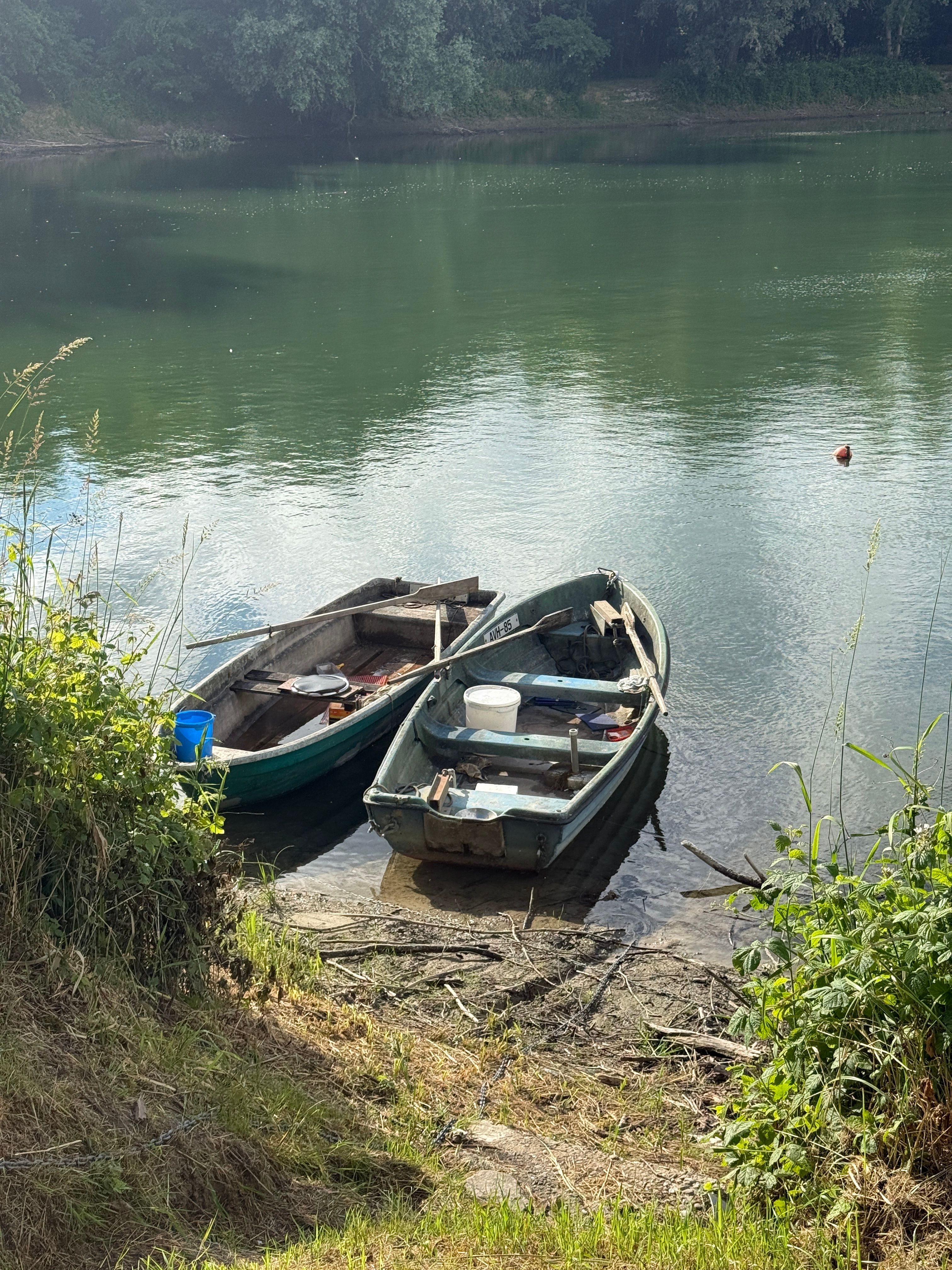 Serene Riverside Scene with Two Rustic Boats · Free Stock Photo