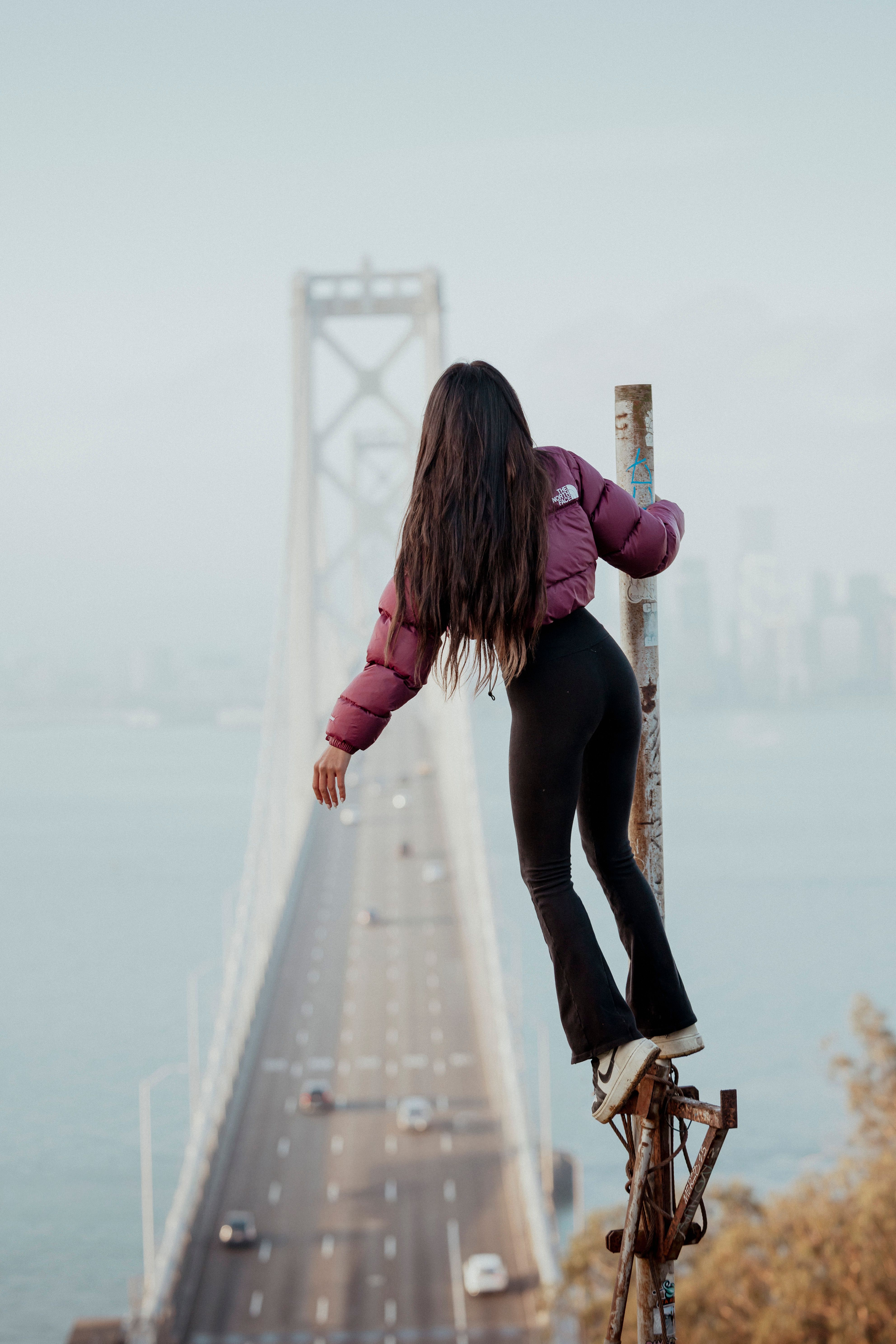 Adventurous Woman Overlooking Iconic Bridge · Free Stock Photo