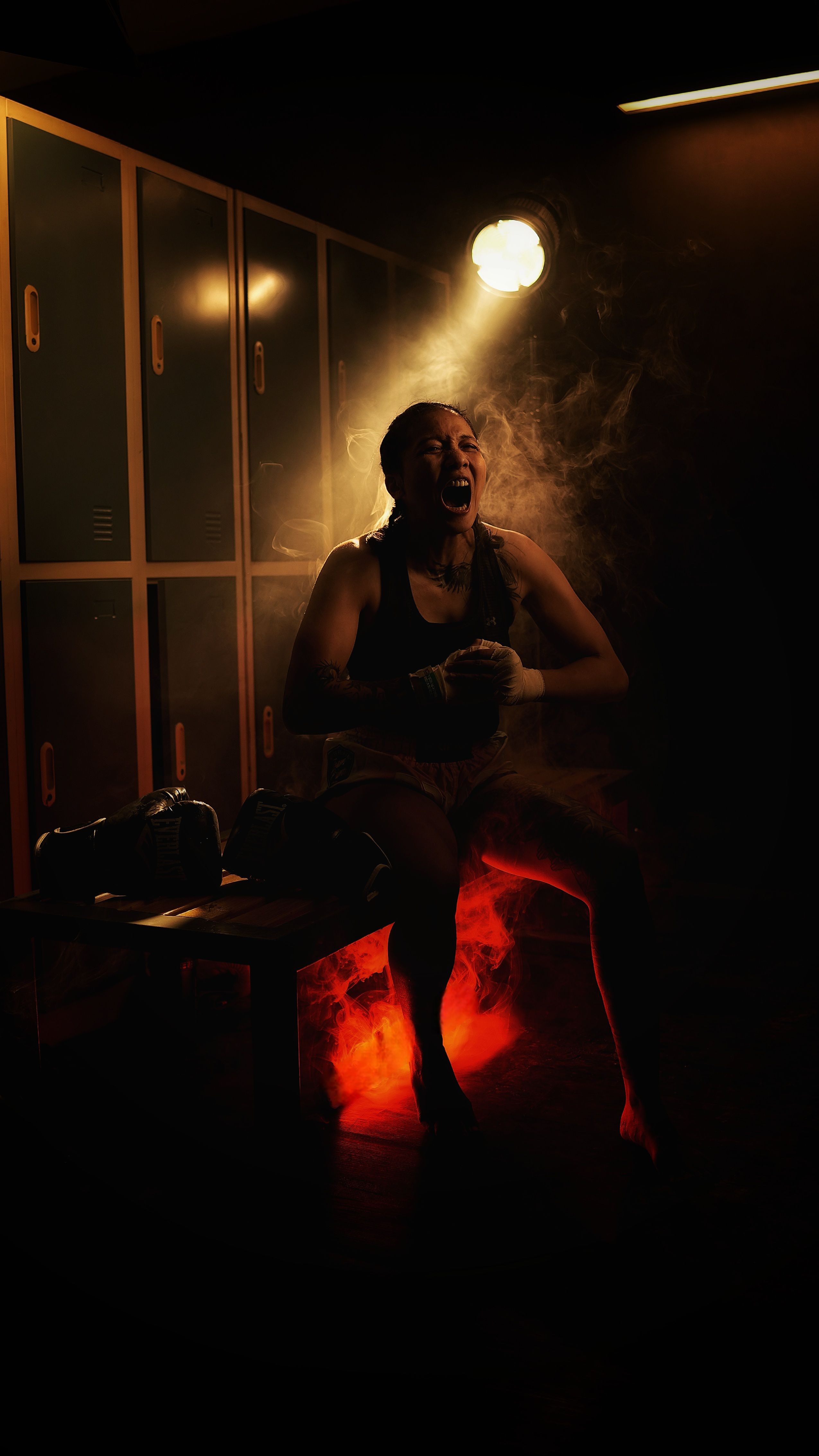 Intense Athlete in Locker Room with Spotlight · Free Stock Photo
