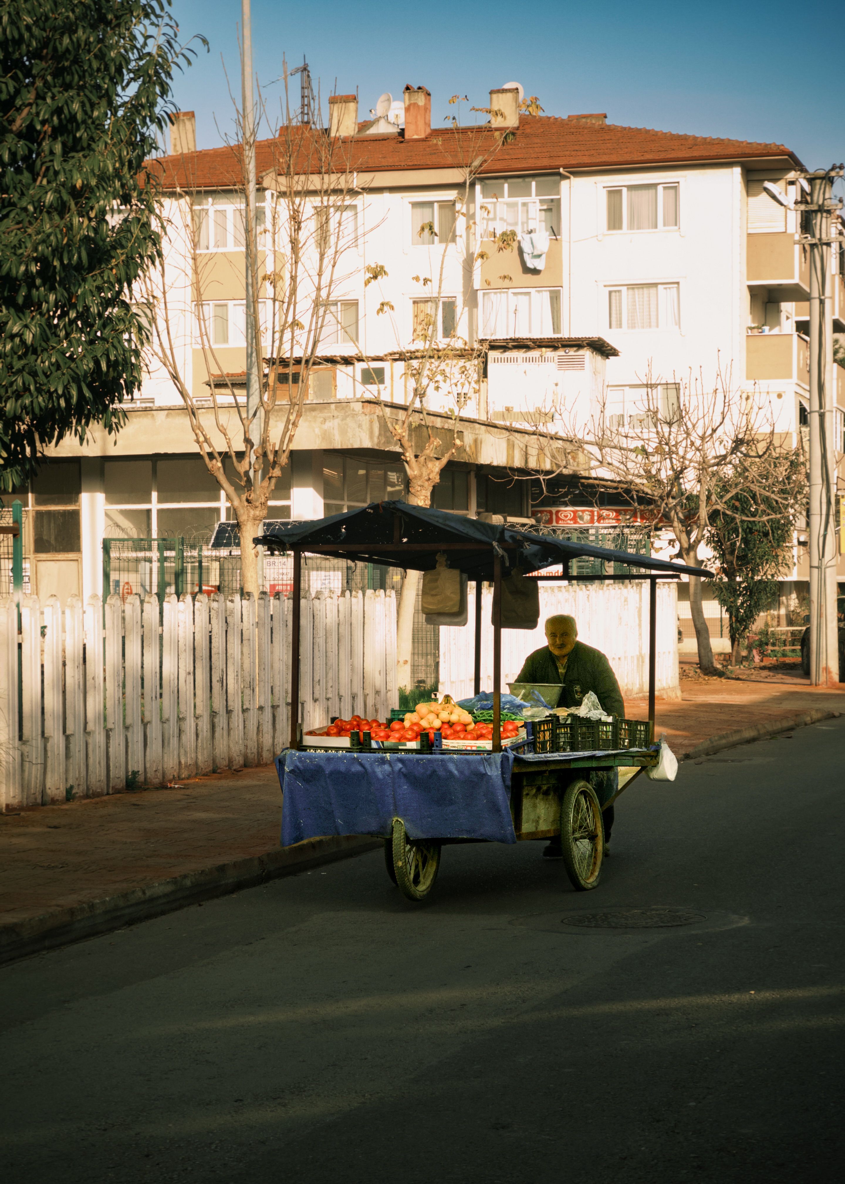 Street Vendor Selling Fresh Produce in Urban Setting · Free Stock Photo