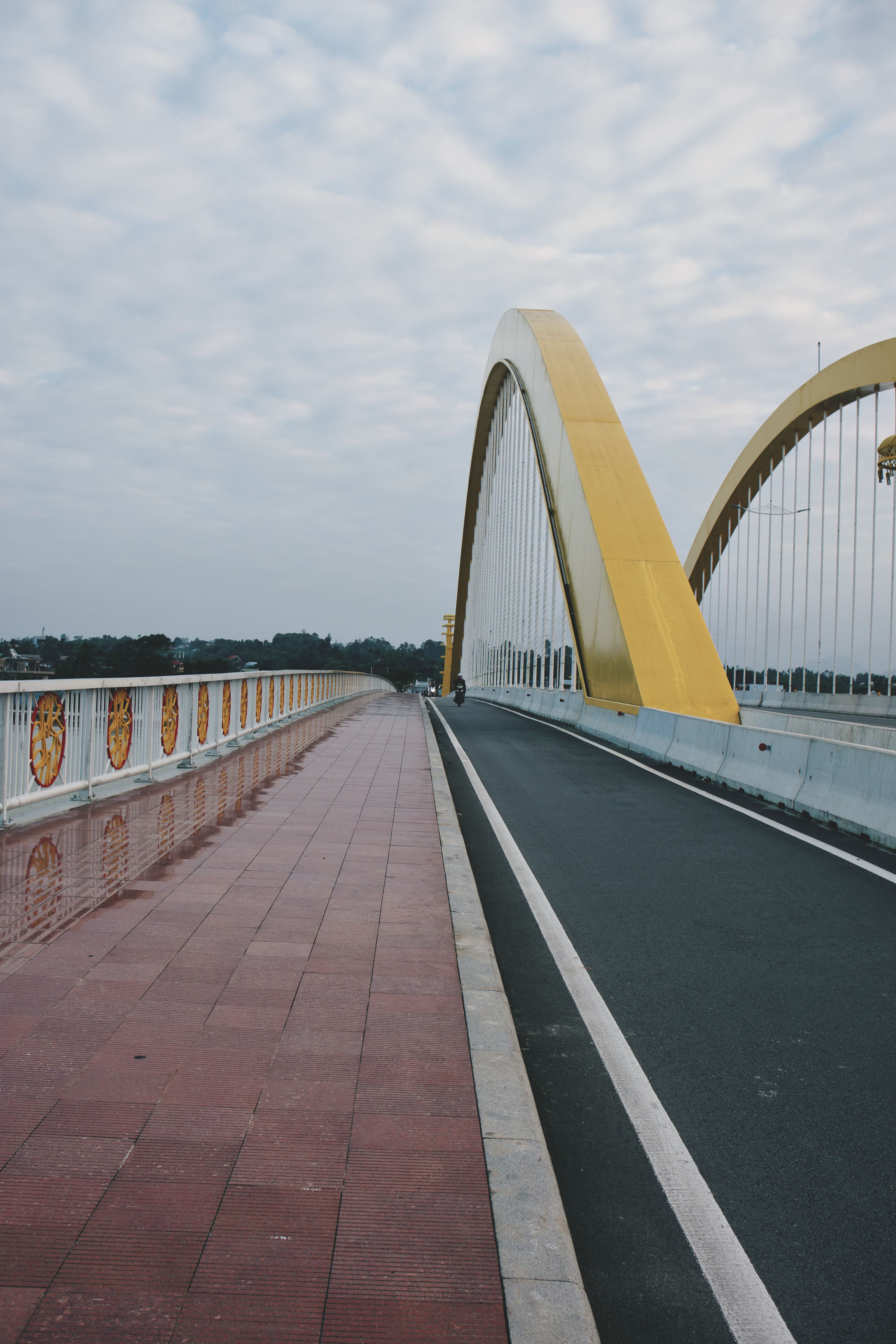 Modern bridge with striking yellow arches under cloudy sky · Free Stock ...