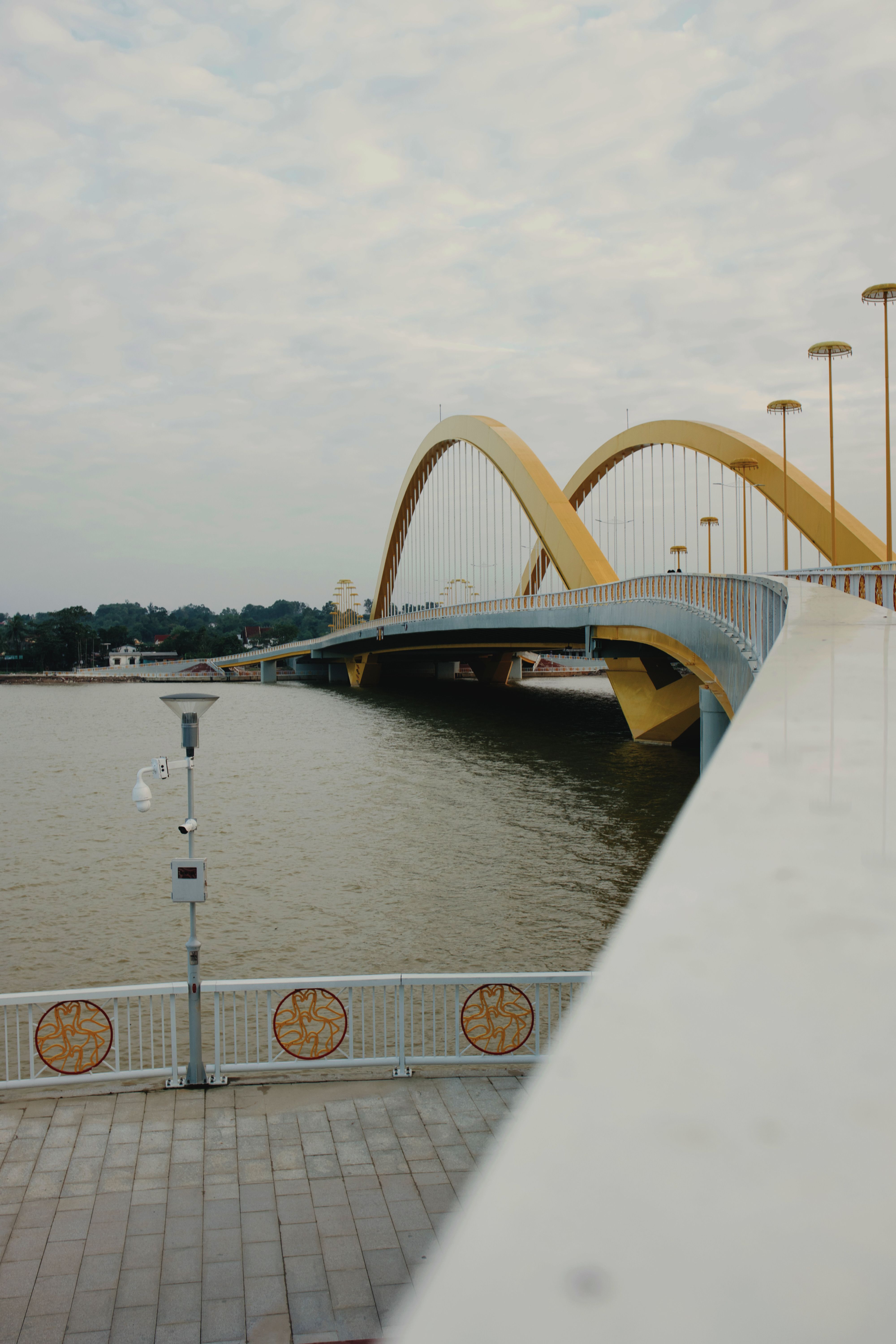 Modern Arch Bridge Over Tranquil River · Free Stock Photo