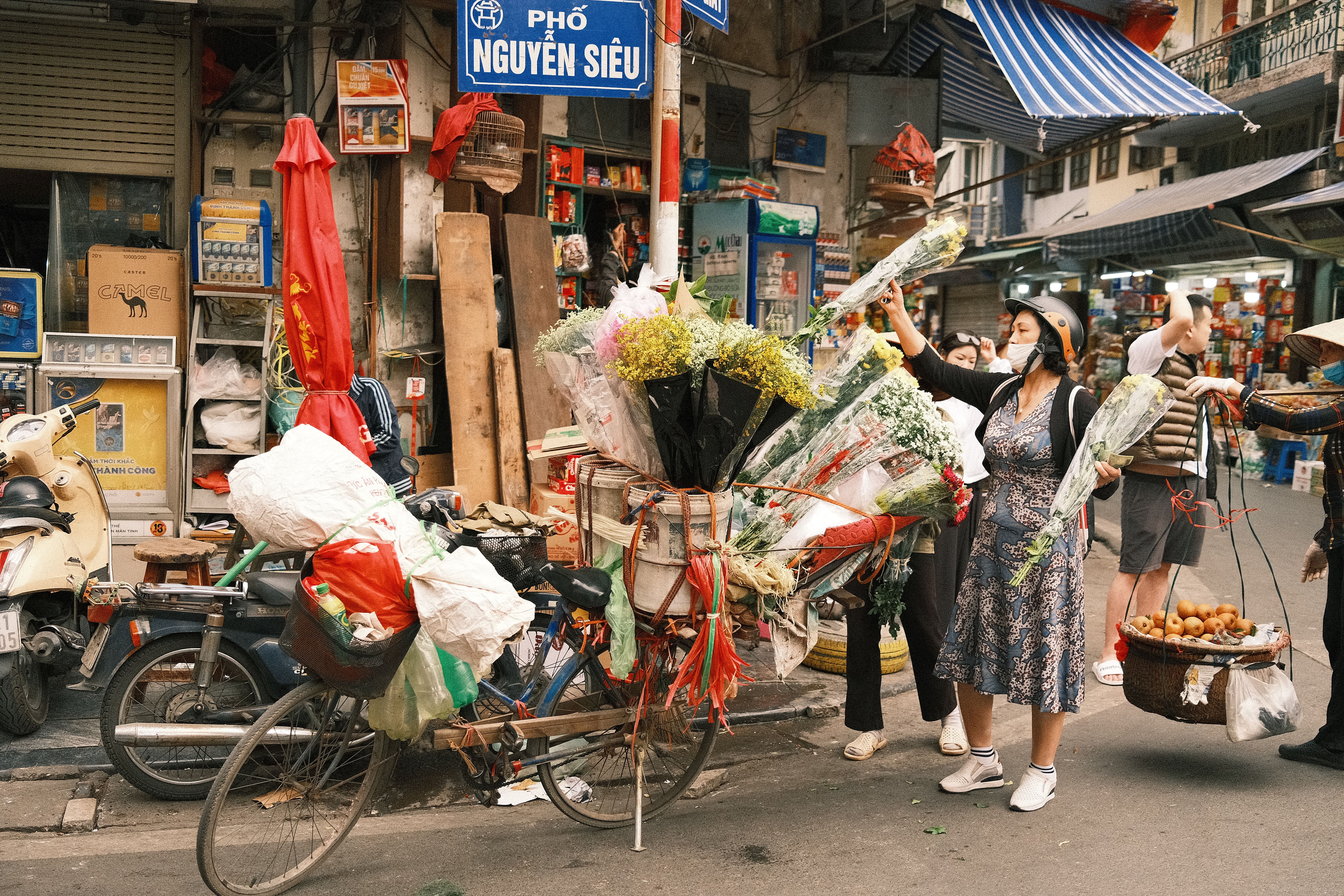 Busy Hanoi Street Scene with Flower Vendor · Free Stock Photo