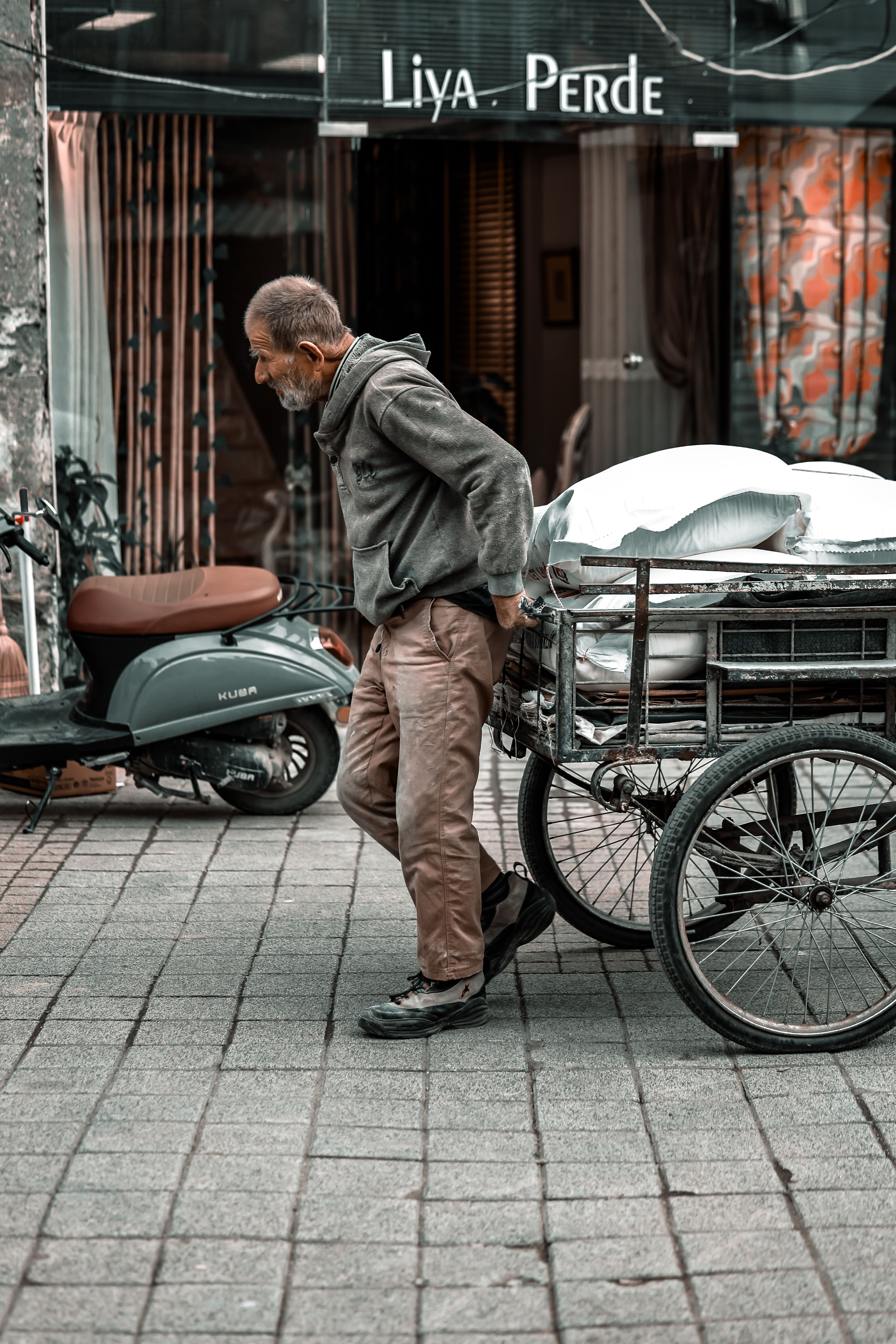 Elderly Man Pulling Cart in City Street · Free Stock Photo