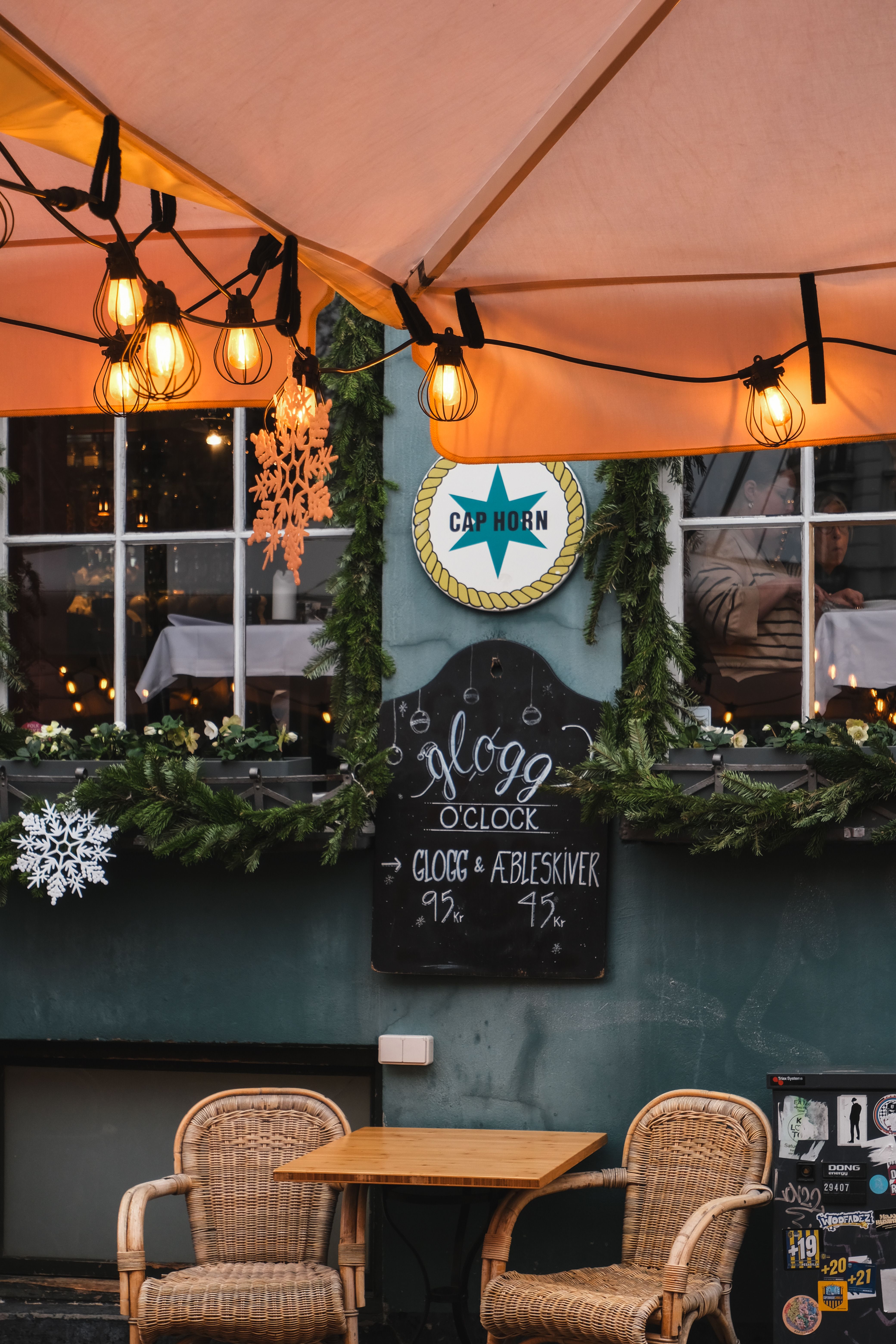 Cozy Outdoor Cafe with Holiday Decorations · Free Stock Photo