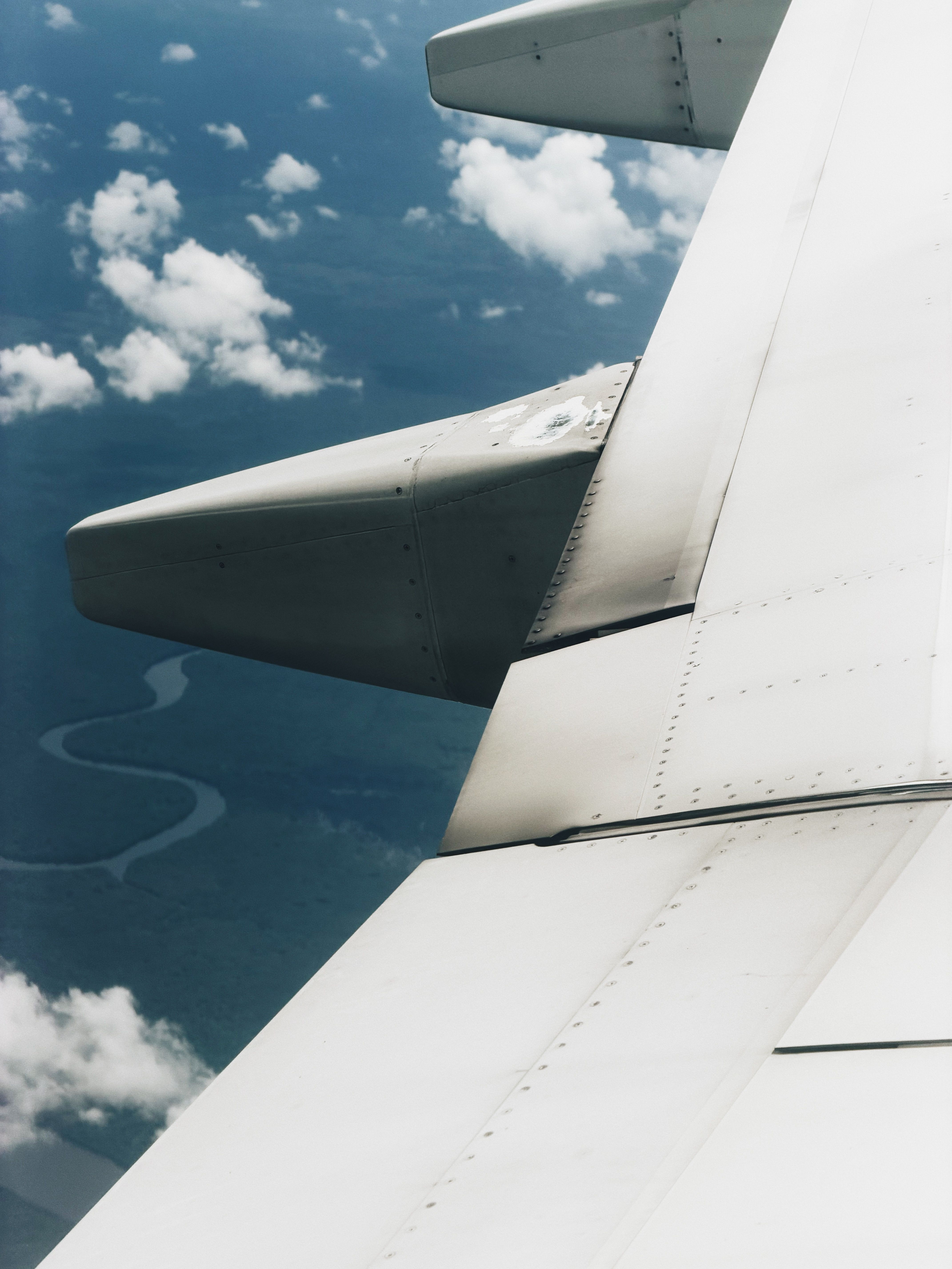 Airplane Wing and Flaps During Flight at Airport · Free Stock Photo