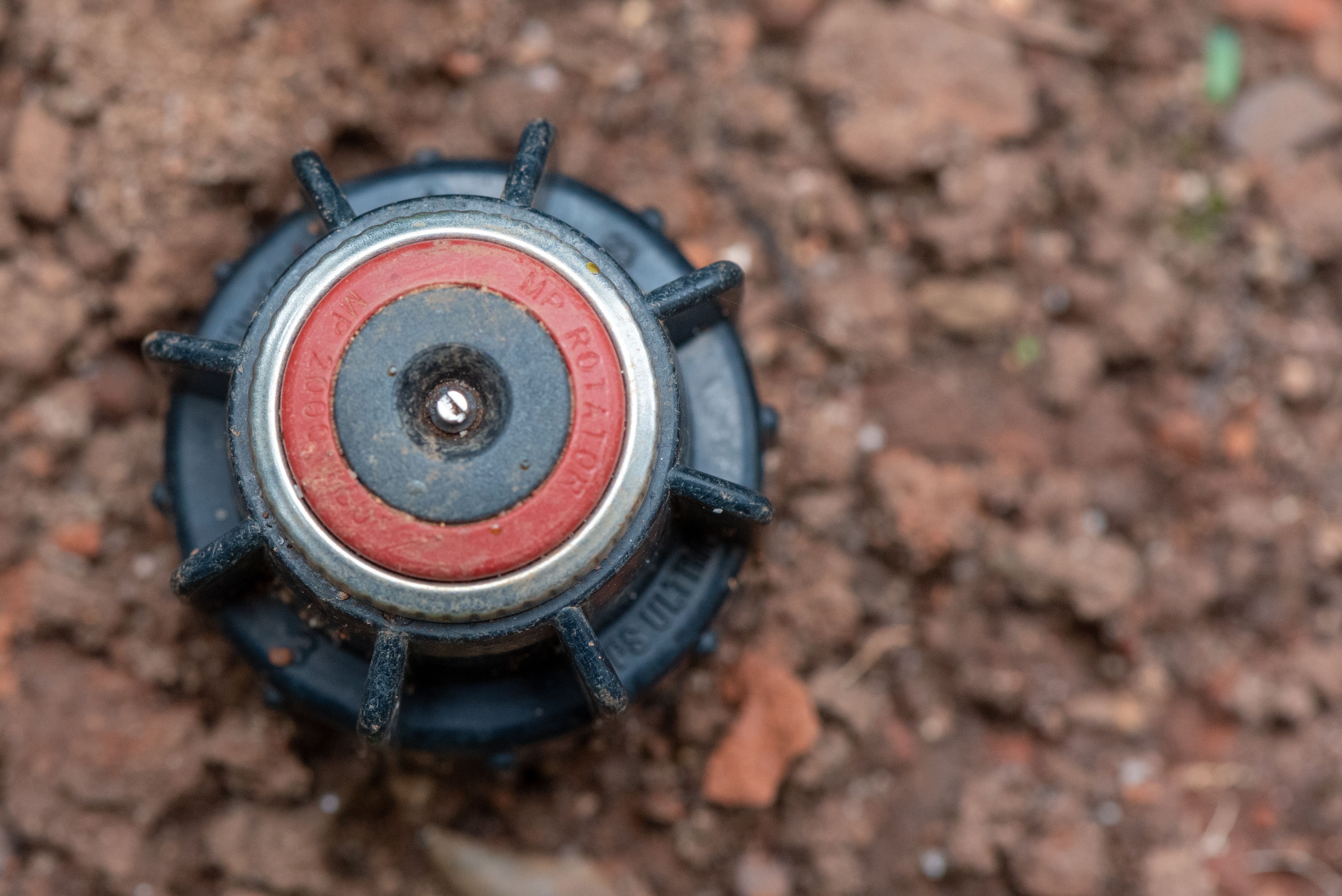 Top view of garden irrigation sprinkler on soil · Free Stock Photo