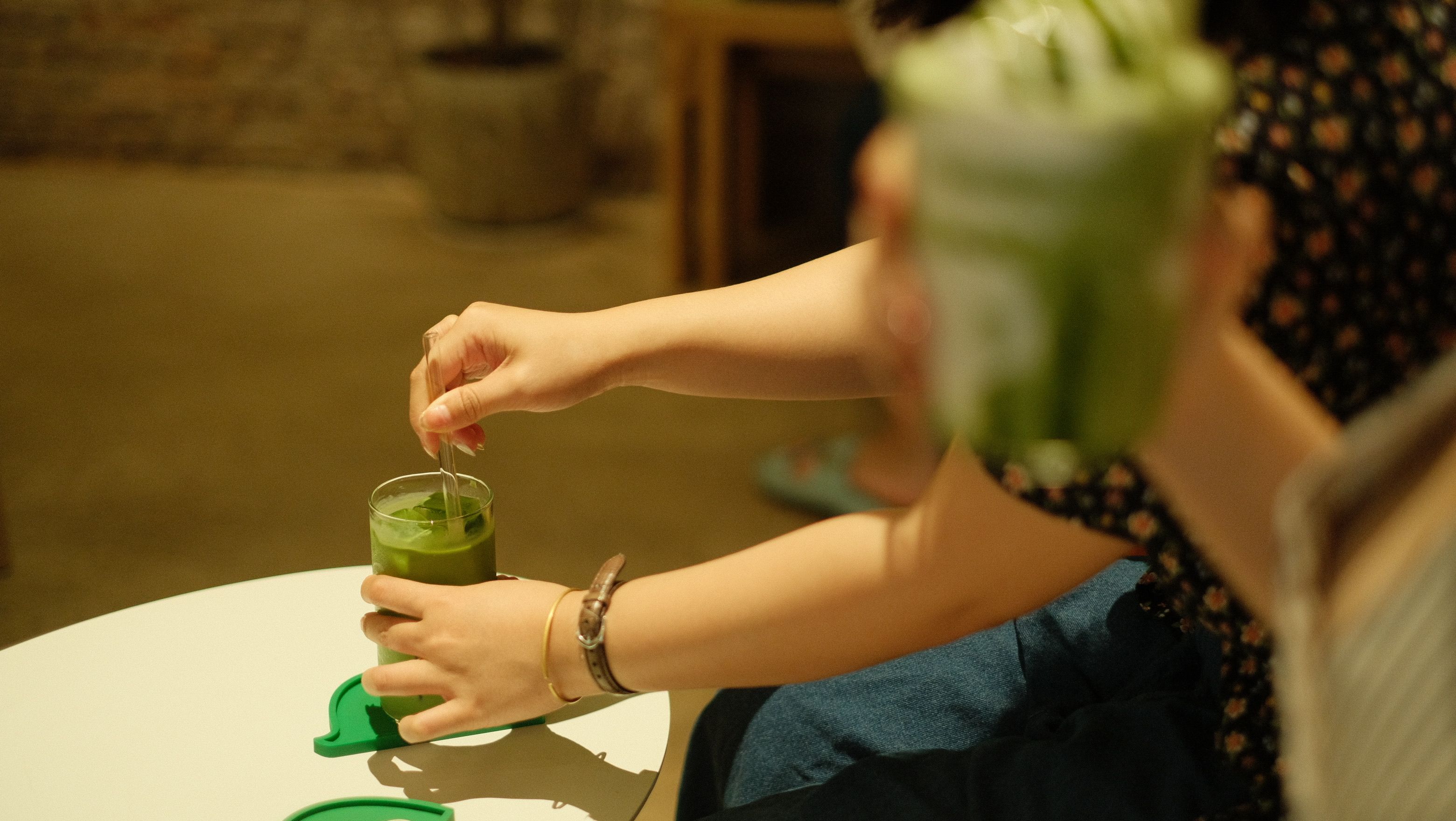 Close-up of people enjoying matcha drinks indoors · Free Stock Photo