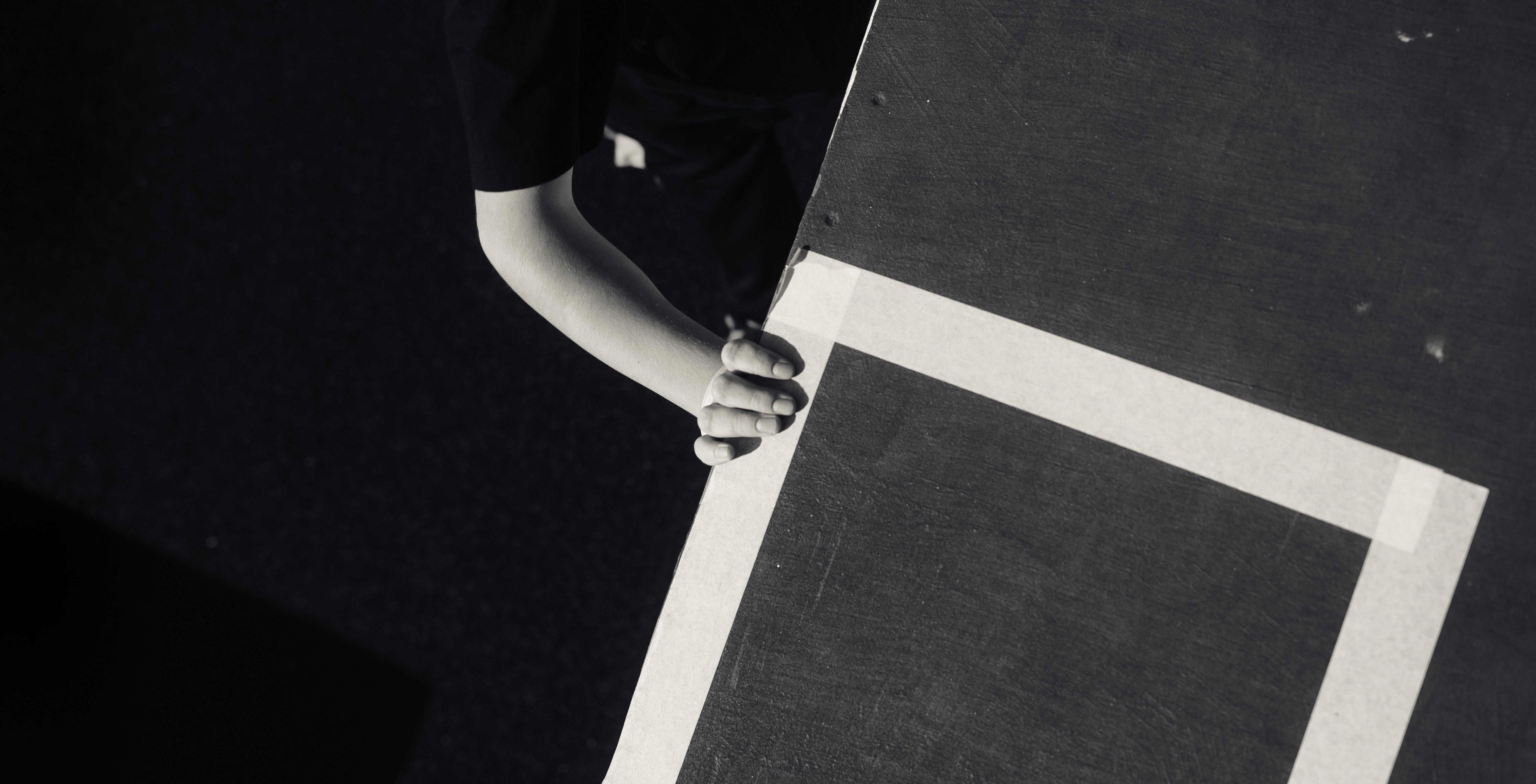Monochrome Arm and Hand on Geometric Pattern · Free Stock Photo