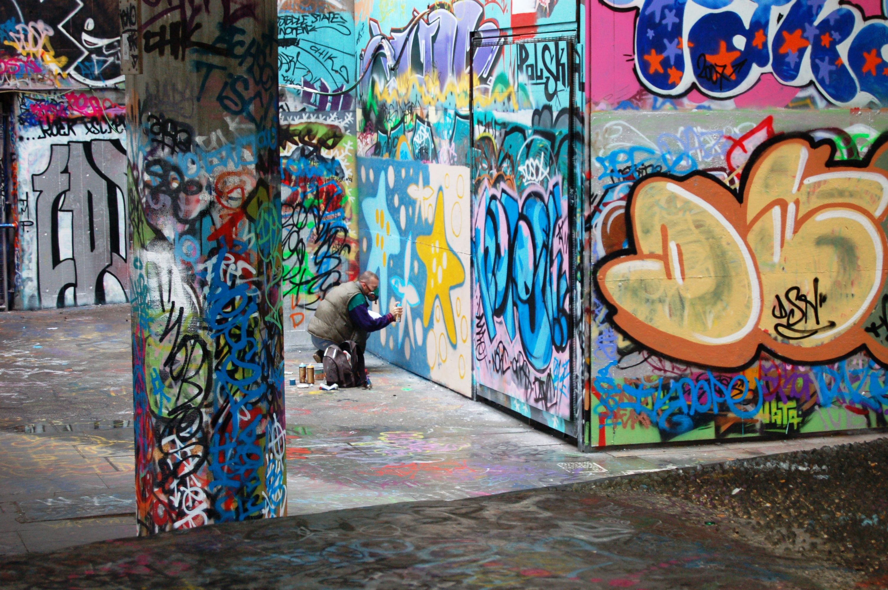 Street Artist Creating Colorful Graffiti Mural · Free Stock Photo